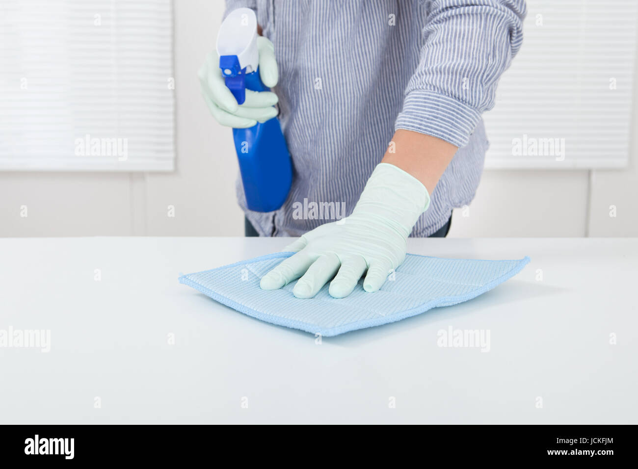 Closeup of woman's hand wiping table with rag at home Stock Photo - Alamy