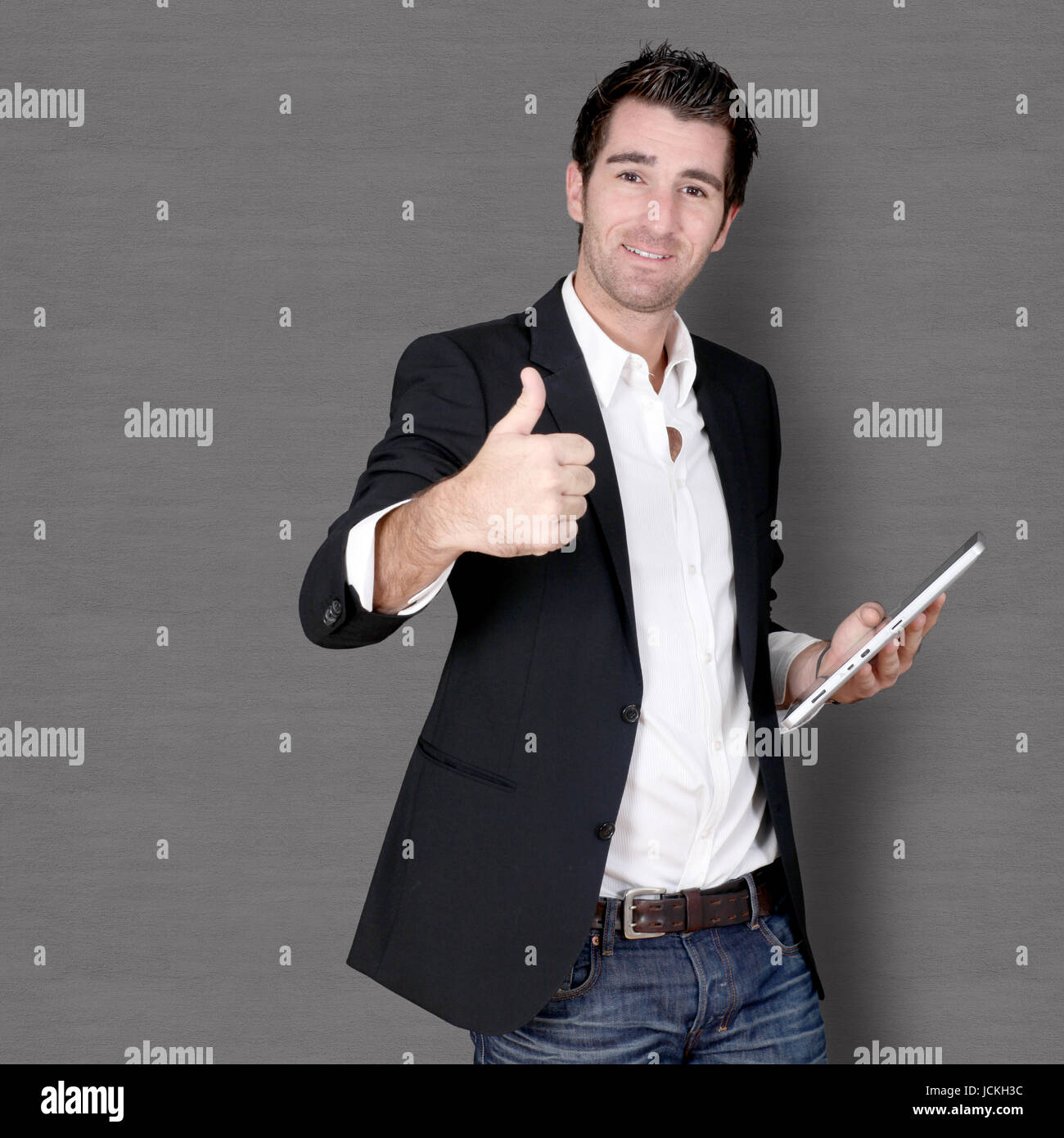 Smiling man standing on dark background Stock Photo - Alamy