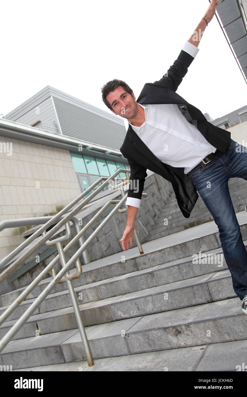 Man running downstairs with stretched arms Stock Photo - Alamy