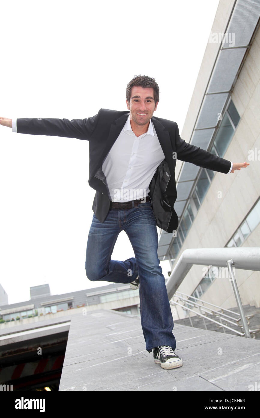 Man running downstairs with stretched arms Stock Photo - Alamy