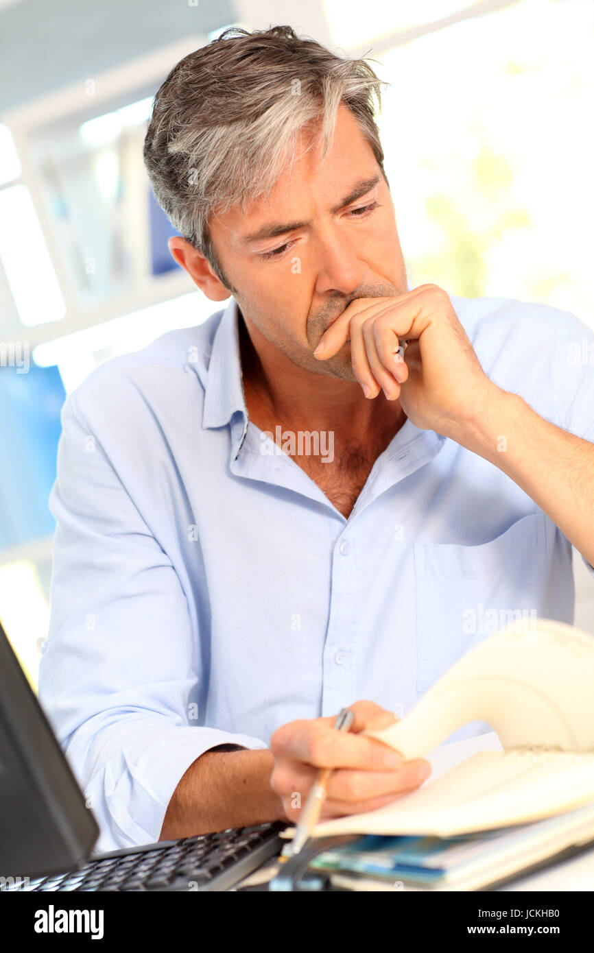 Man in office with worried look on his face Stock Photo - Alamy
