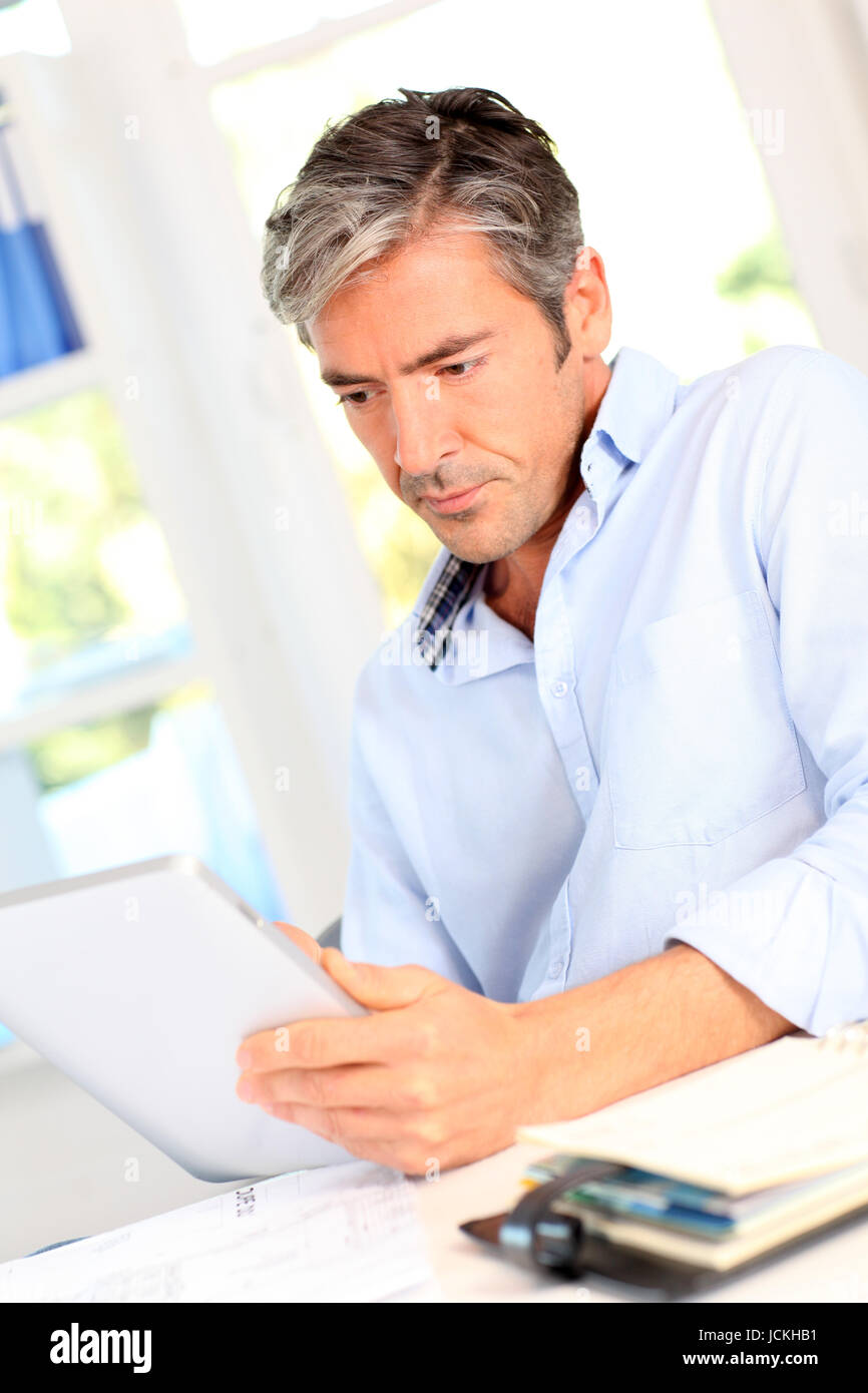 Office worker using electronic tablet Stock Photo - Alamy