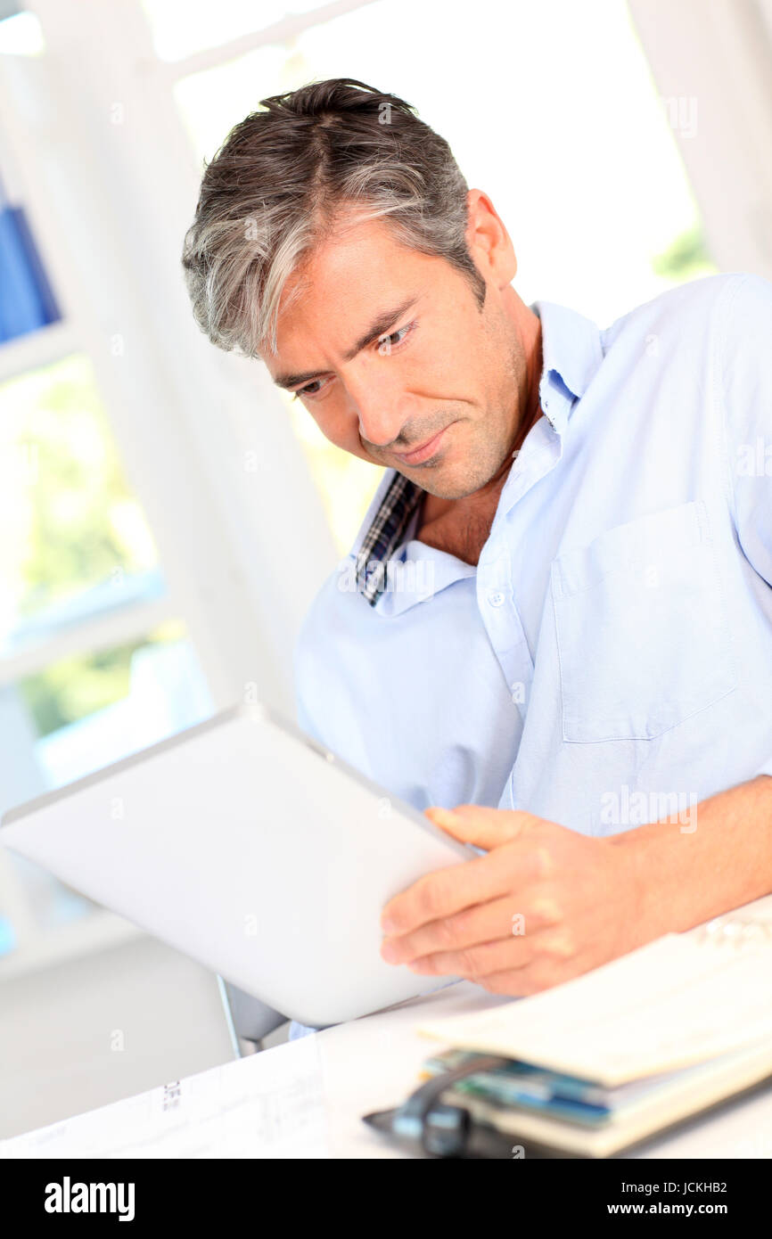 Office worker using electronic tablet Stock Photo - Alamy