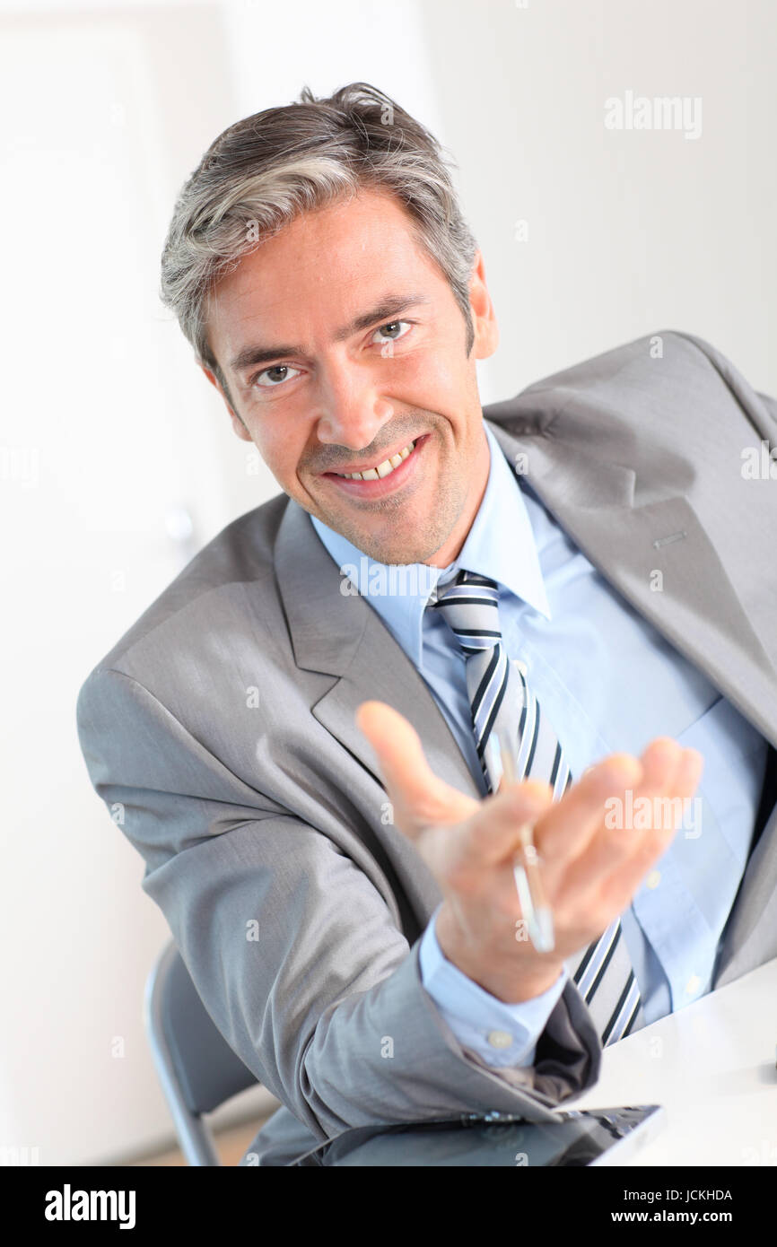 Businessman giving product advantages to client Stock Photo - Alamy