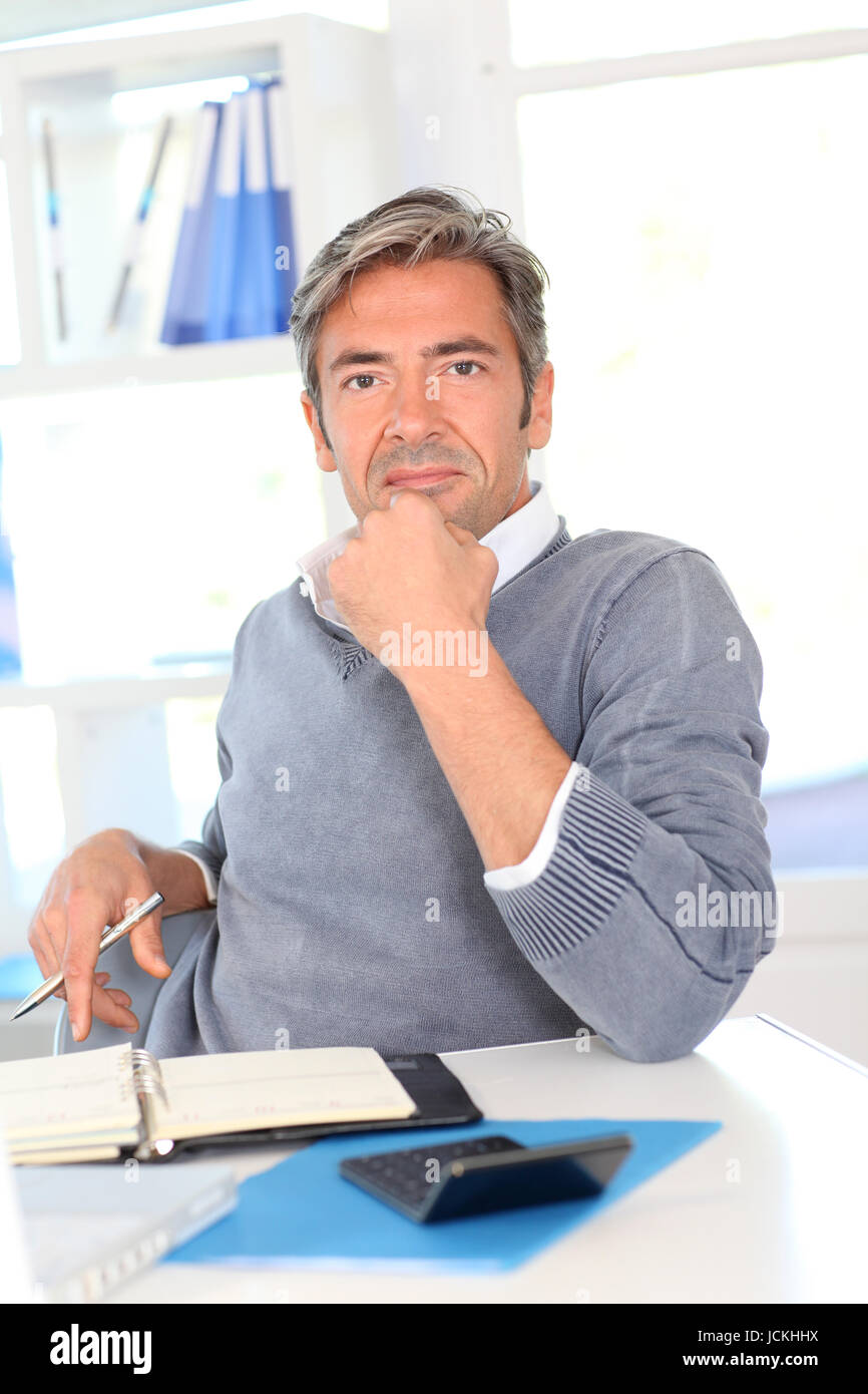 Man sitting at his desk in office Stock Photo - Alamy