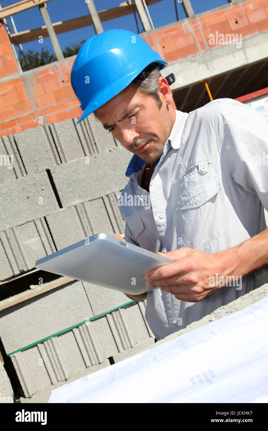 Construction manager using electronic tablet hi-res stock photography ...