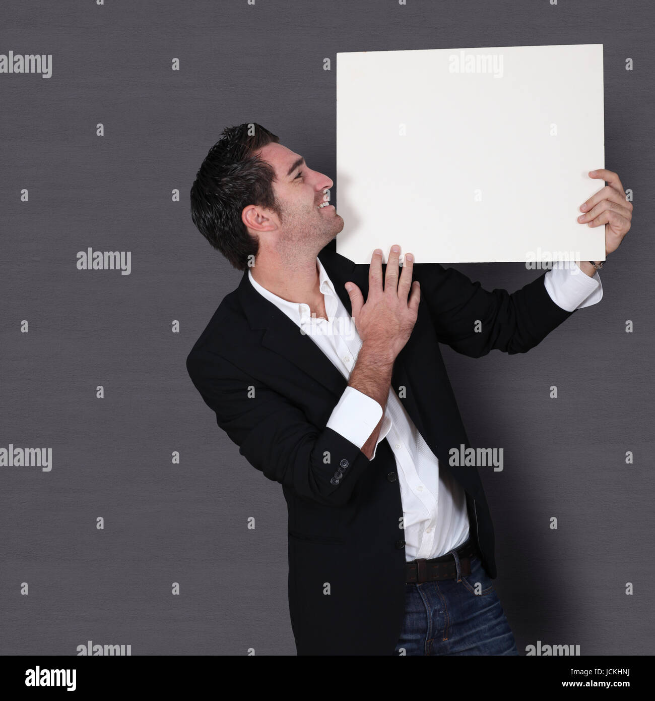 Funny salesman holding whiteboard Stock Photo - Alamy