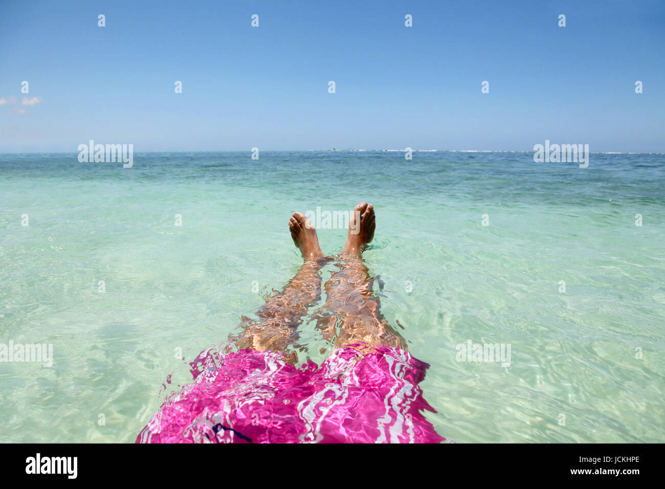 Closeup of man's feet floating in blue lagoon water Stock Photo - Alamy