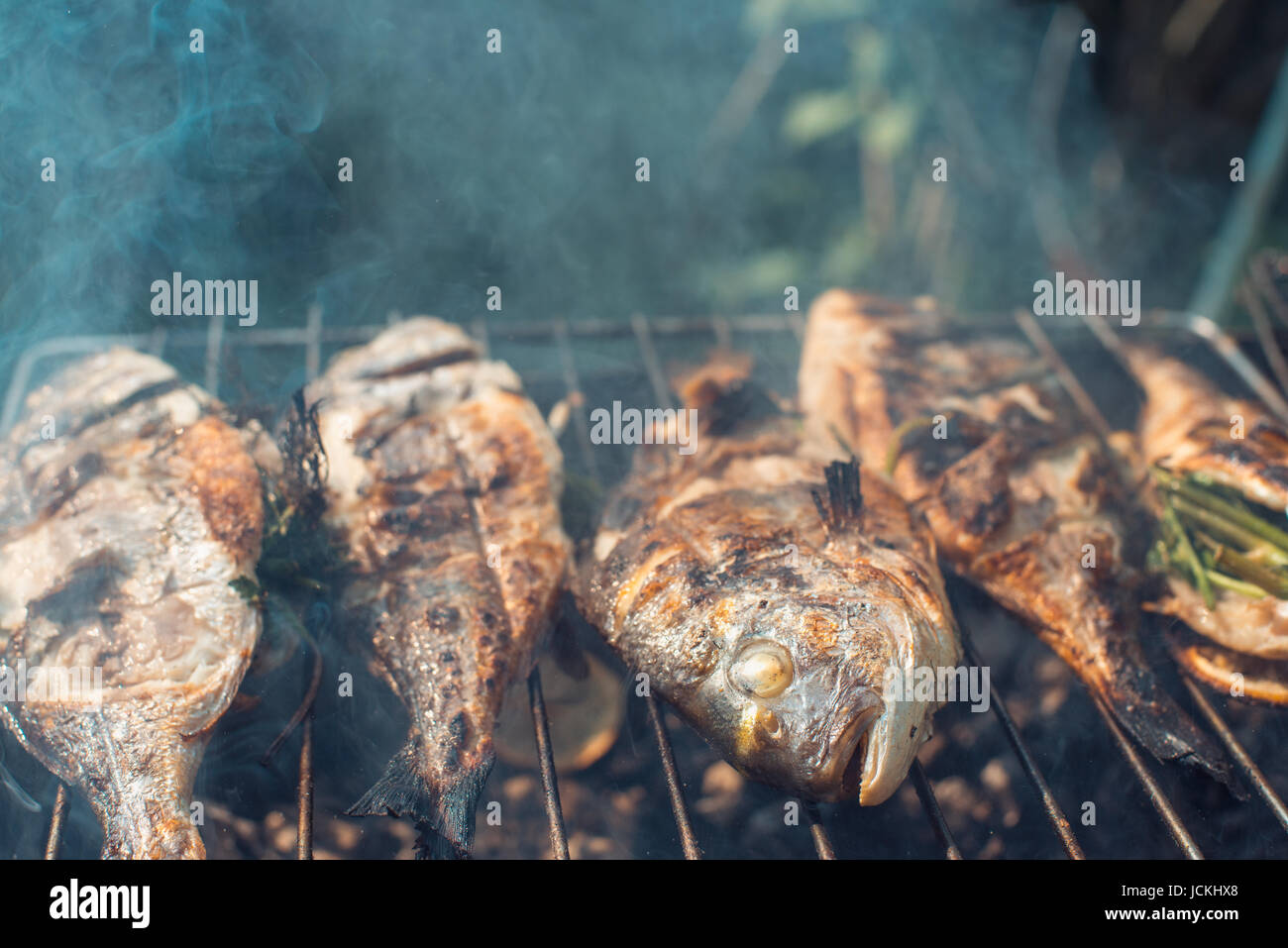 Grilled fish with lemon on the grid Barbeque in the garden in summer ...
