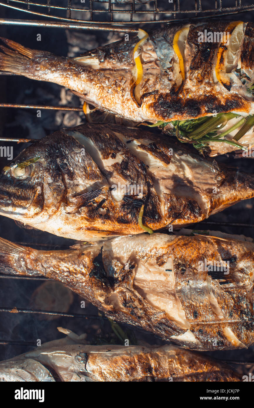 Grilled fish with lemon on the grid Barbeque in the garden in summer ...