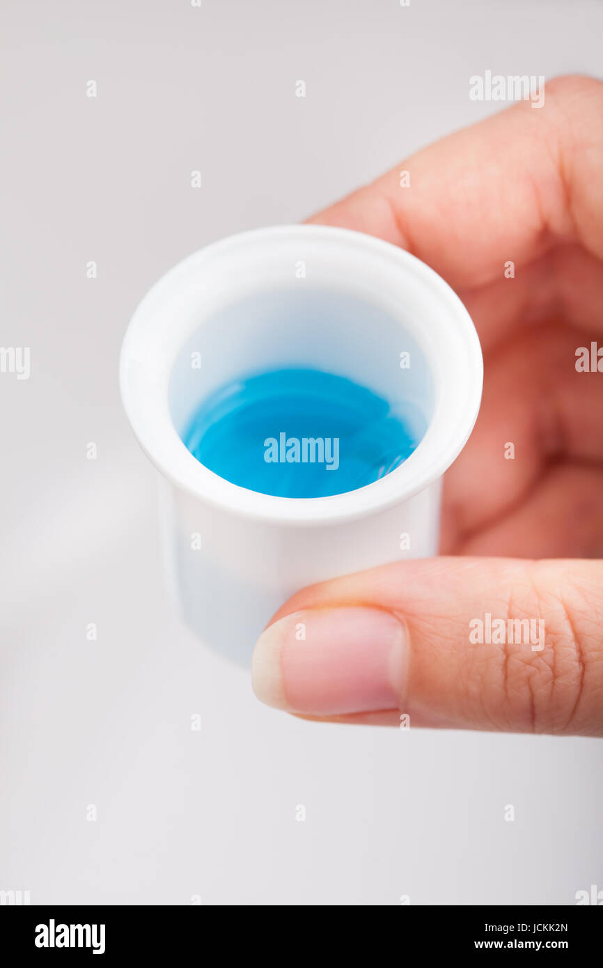 Close-up Of Person's Hand Pouring Liquid In Container Stock Photo - Alamy