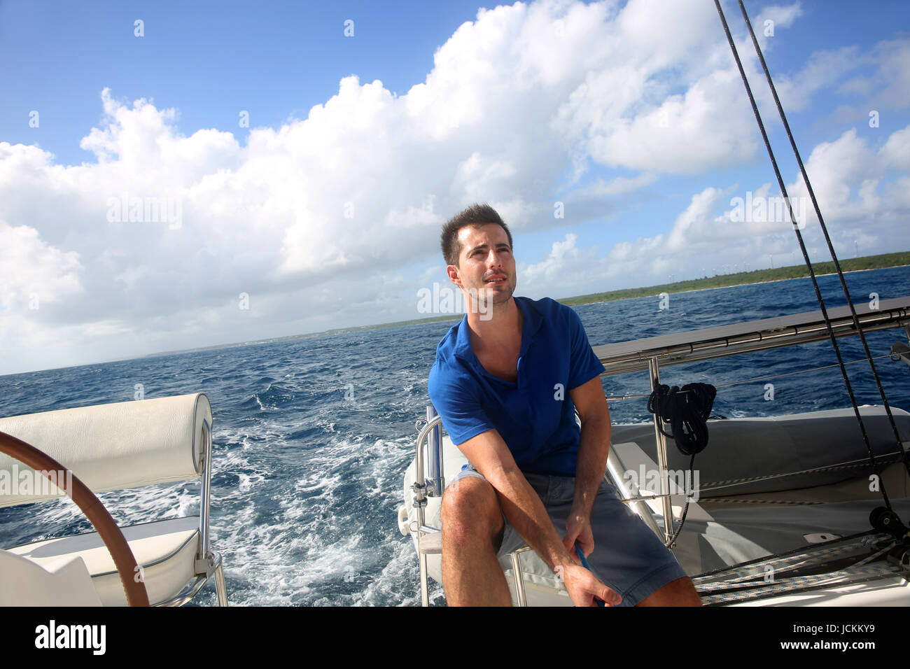 Sailot pulling on sail rope during navigation Stock Photo - Alamy