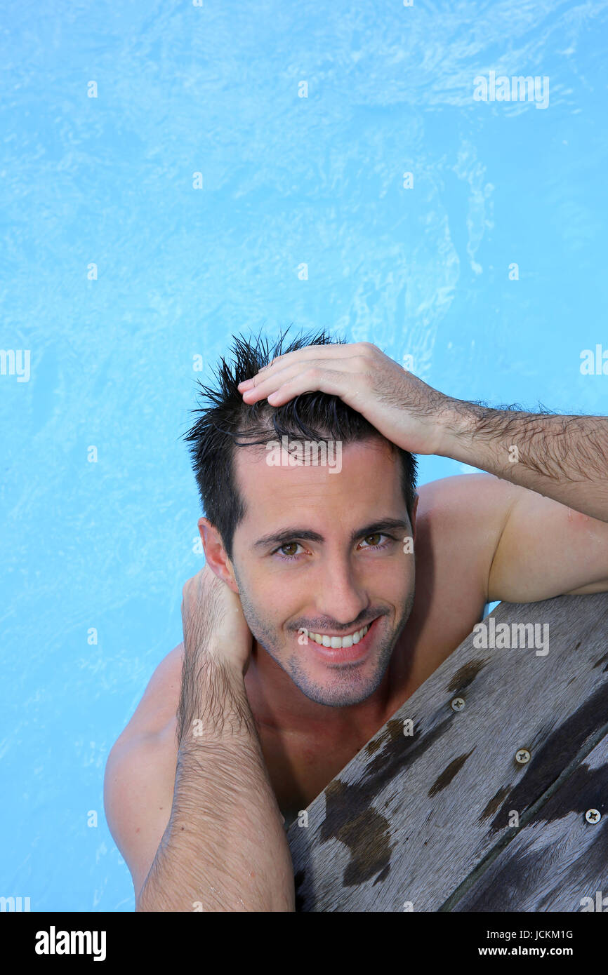 Portrait of smiling guy in swimming pool Stock Photo - Alamy