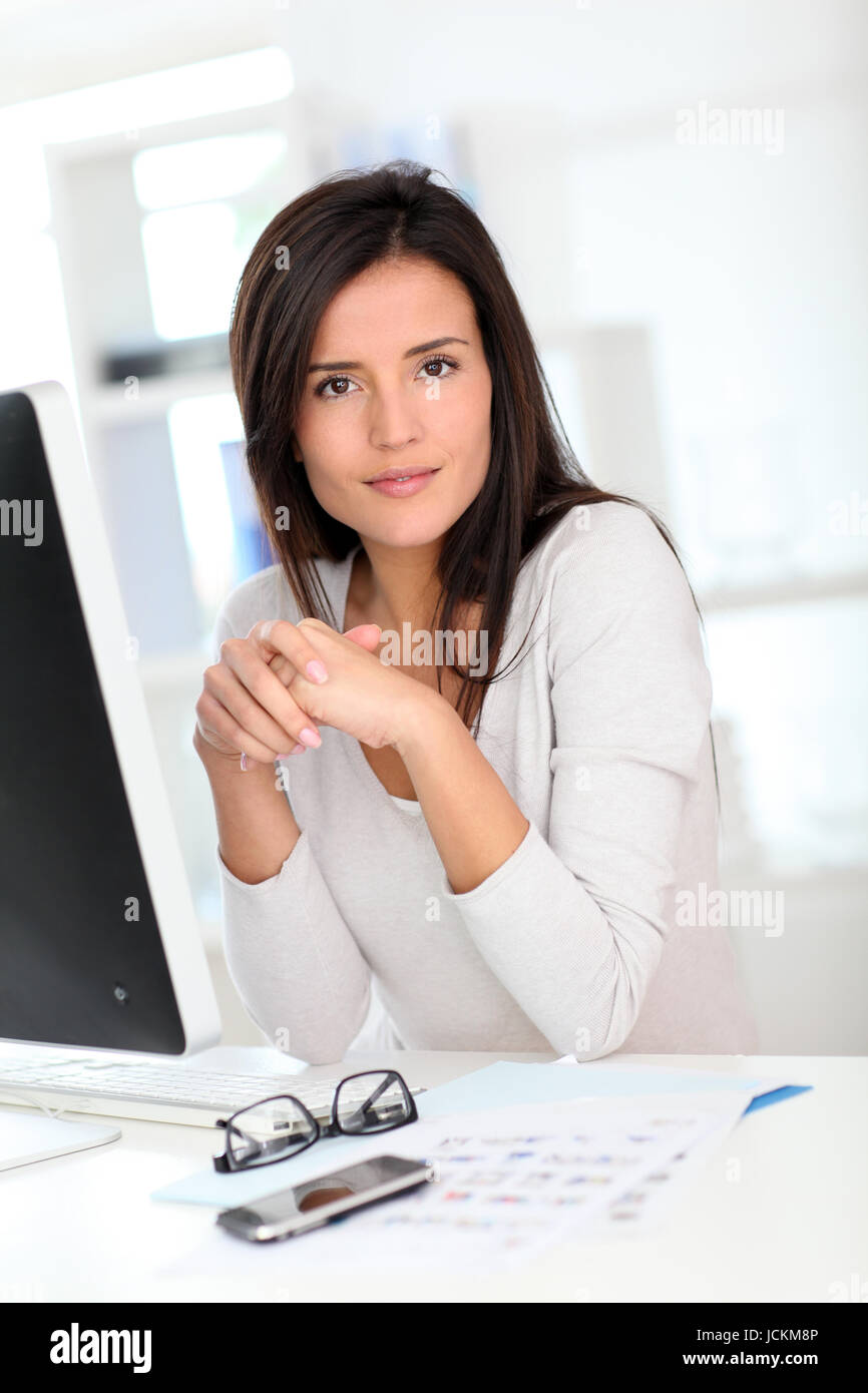 Beautiful office worker in front of desktop computer Stock Photo - Alamy