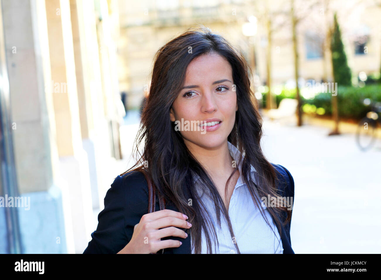 Young woman walking in town Stock Photo - Alamy