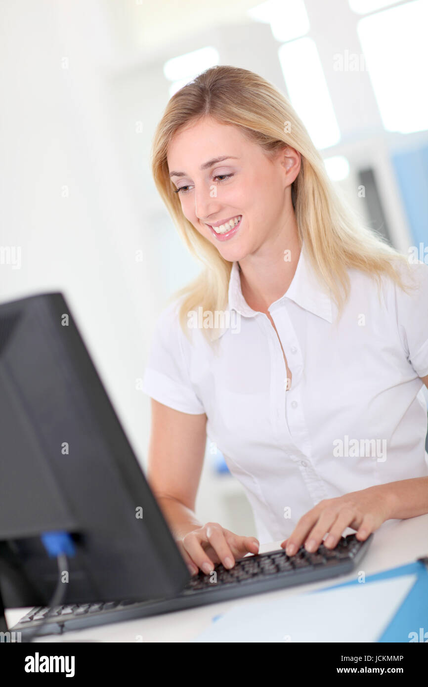 Office-worker sitting in front of desktop computer Stock Photo - Alamy