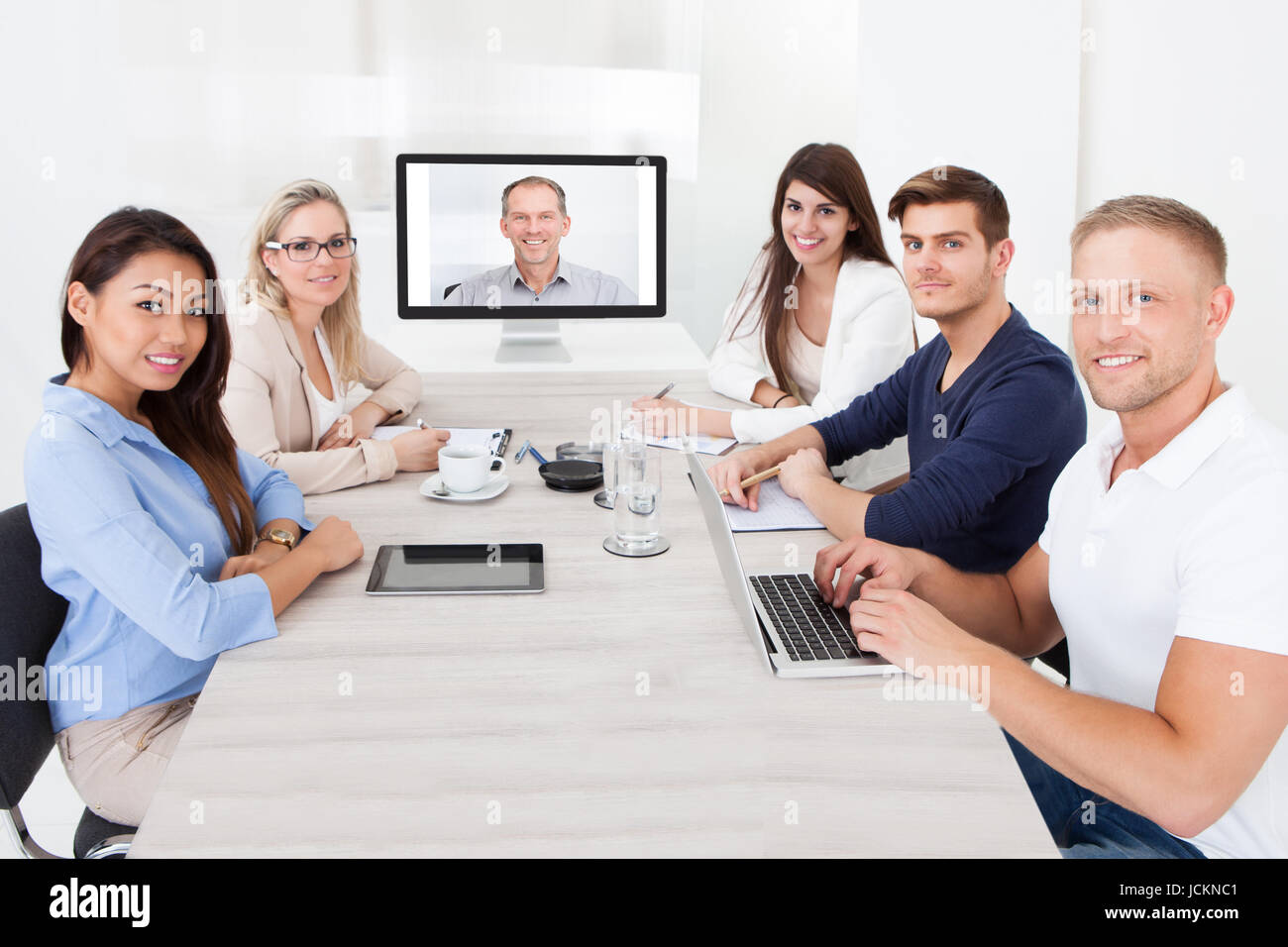 Businesspeople attending video conference hi-res stock photography and ...