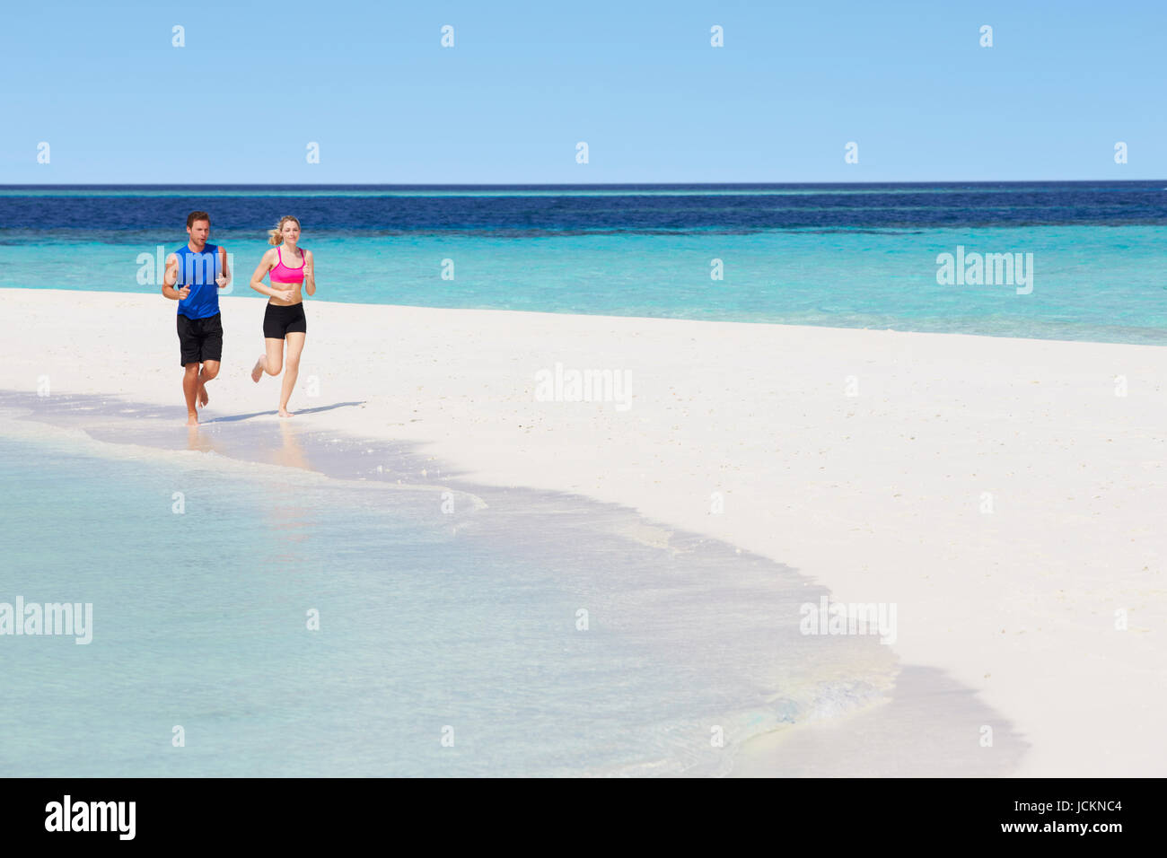 Couple Running On Beautiful Beach Stock Photo - Alamy