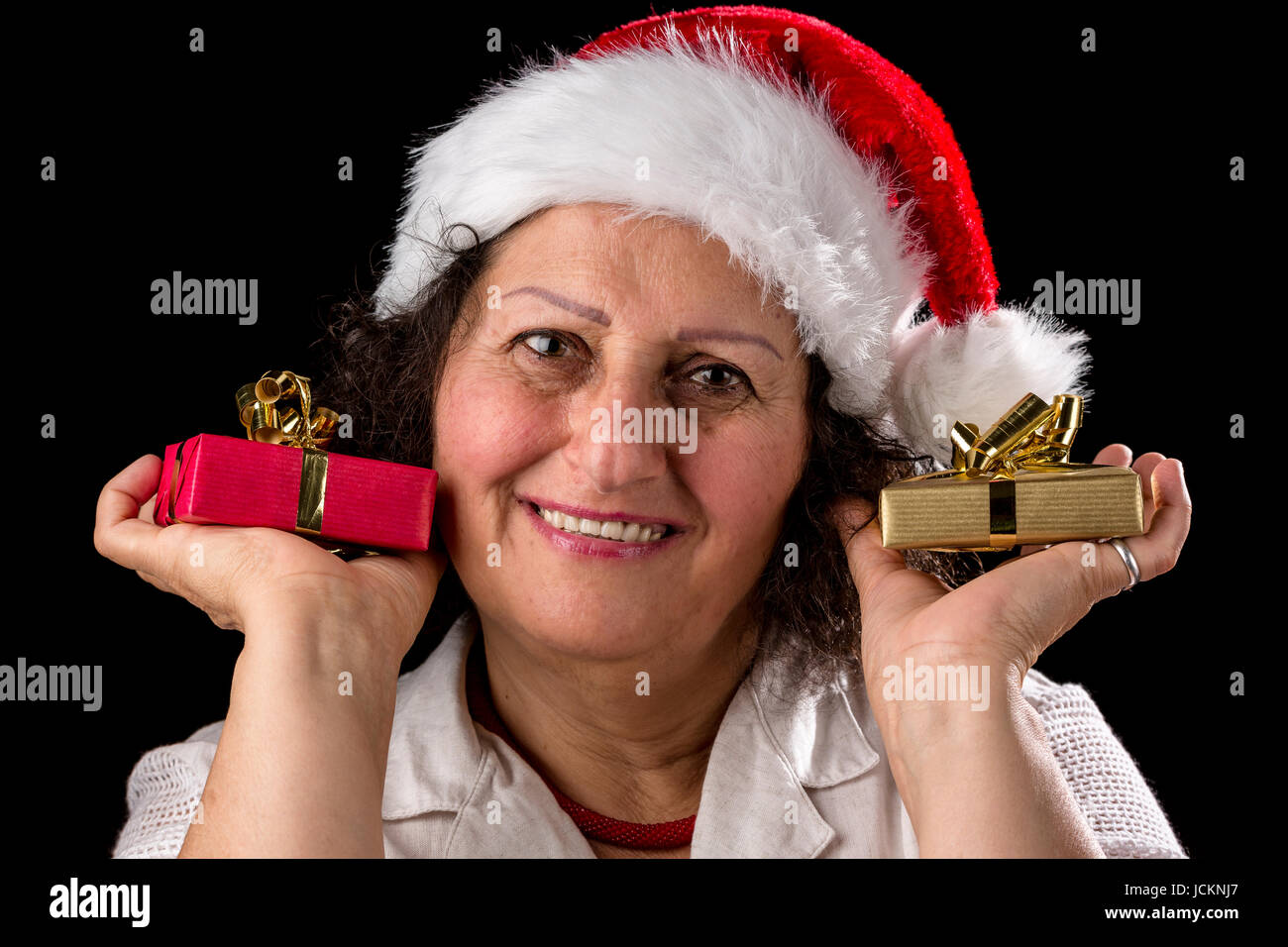 Venerable middle-aged woman with a Kris Kringle hat cracking a smile ...