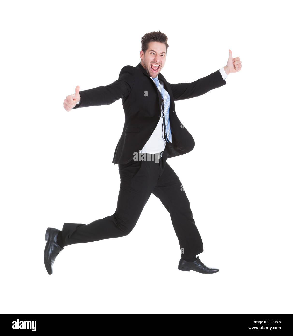 Full length portrait of young businessman running while gesturing ...