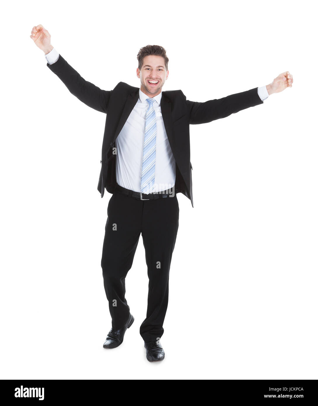 Full length portrait of young businessman celebrating success over ...