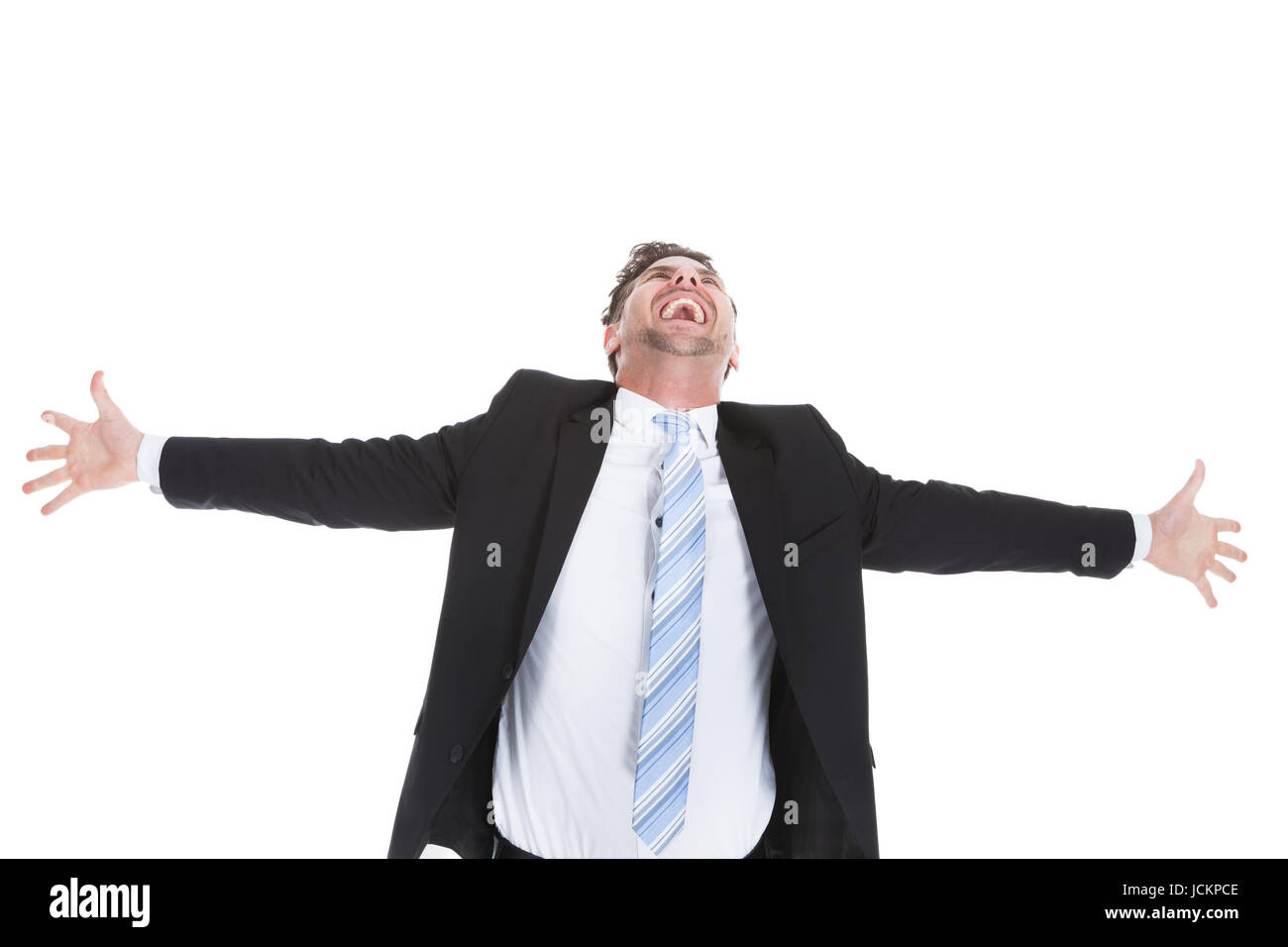 Full length portrait of young businessman celebrating success over ...