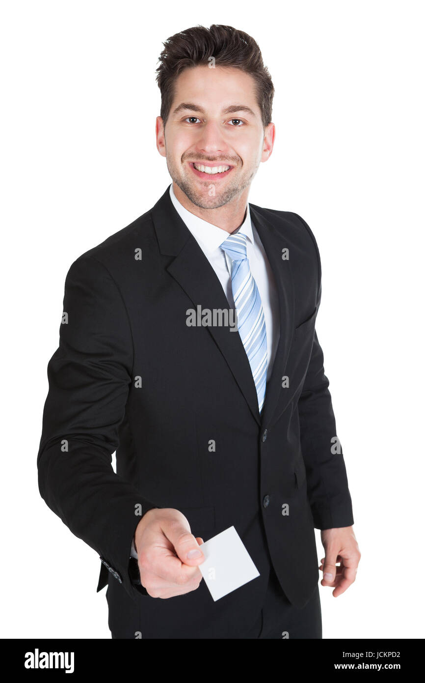 Portrait of happy businessman holding visiting card over white ...