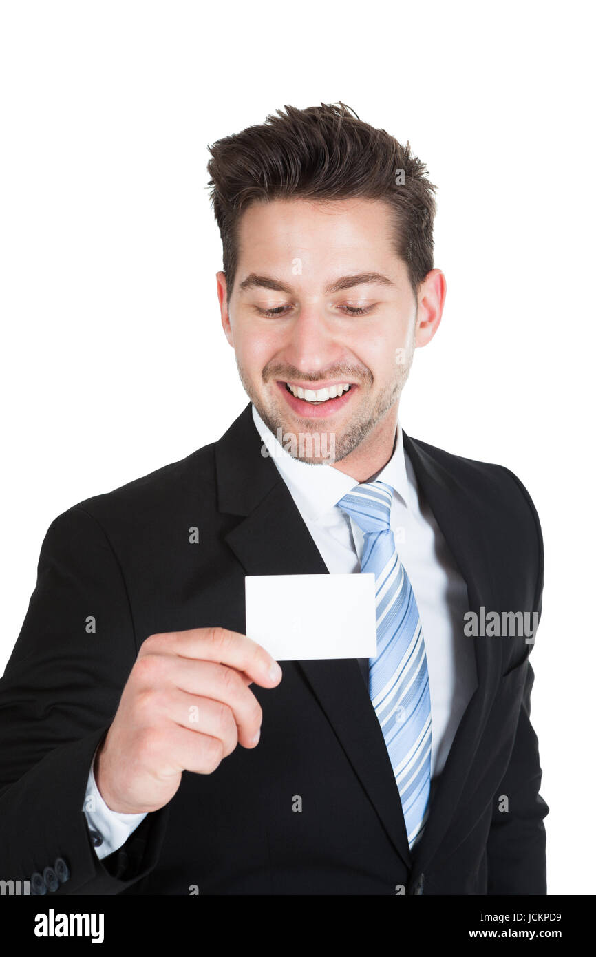 Portrait of happy businessman holding visiting card over white ...