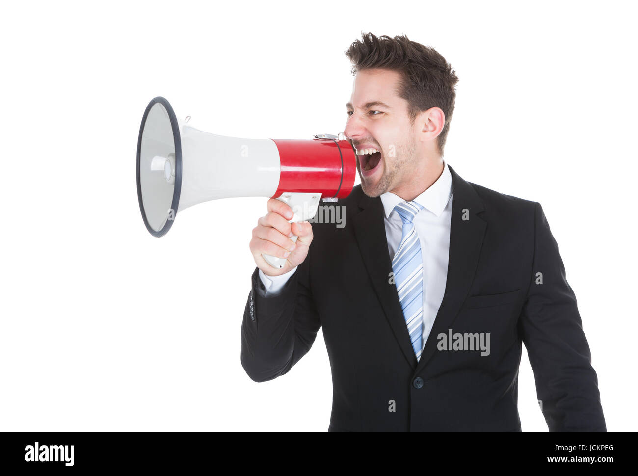 Full length of young businessman screaming into megaphone over white ...