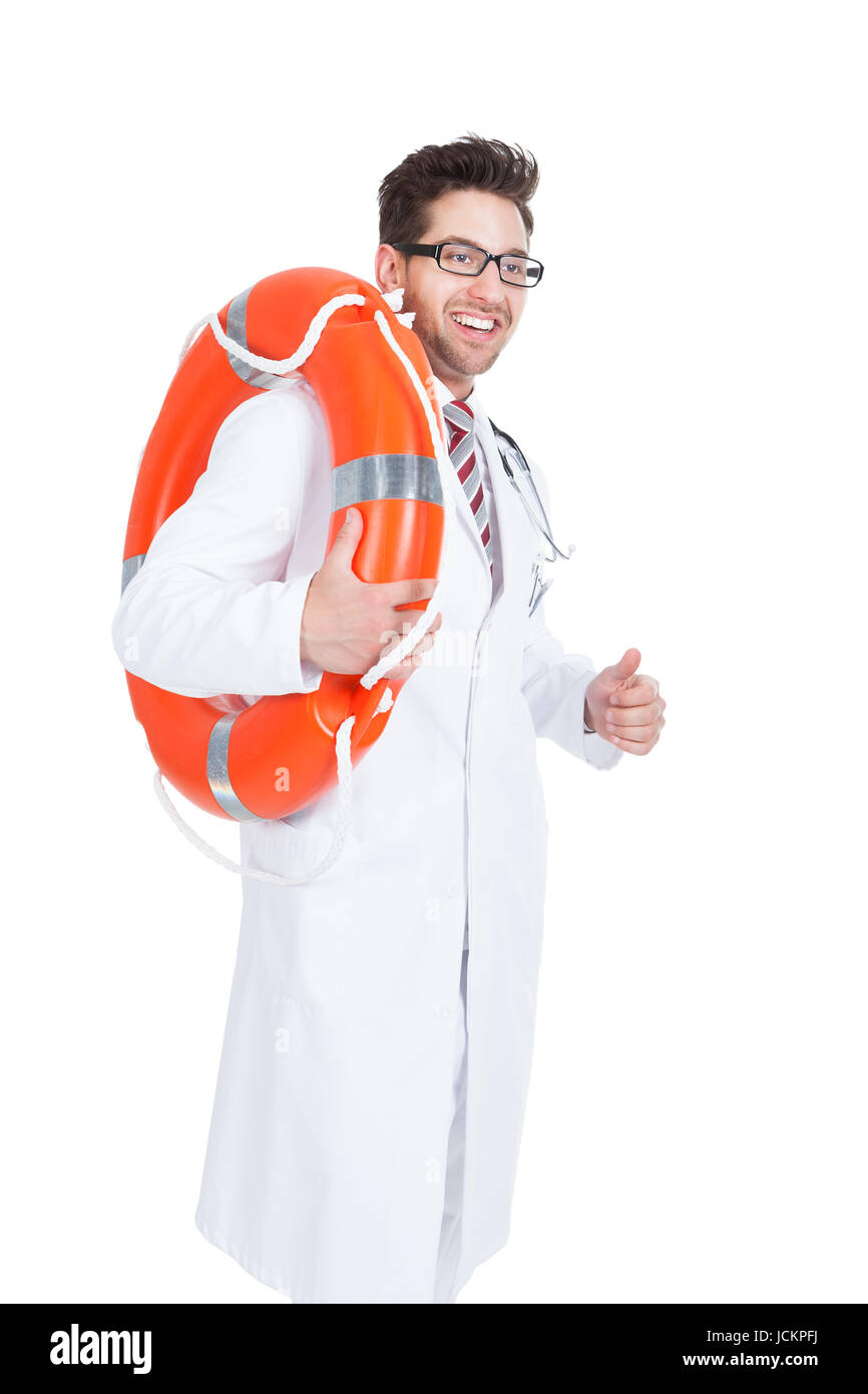 Portrait of confident young male doctor looking through lifebuoy over ...