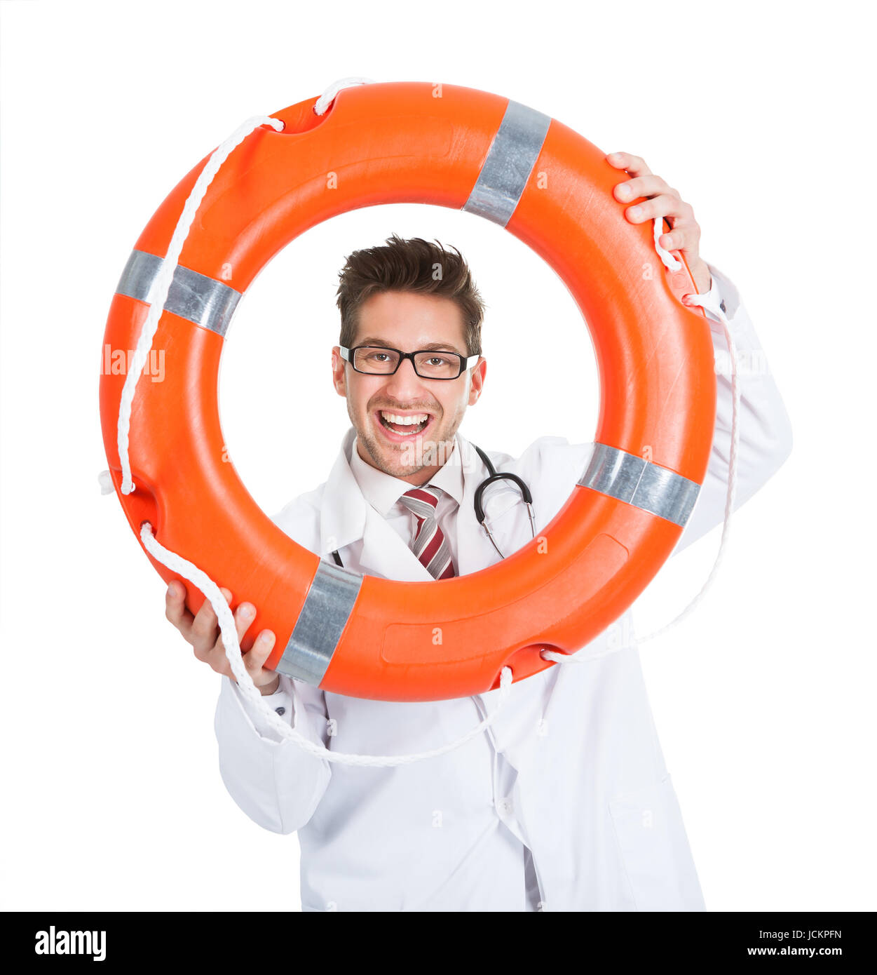 Portrait of confident young male doctor looking through lifebuoy over ...