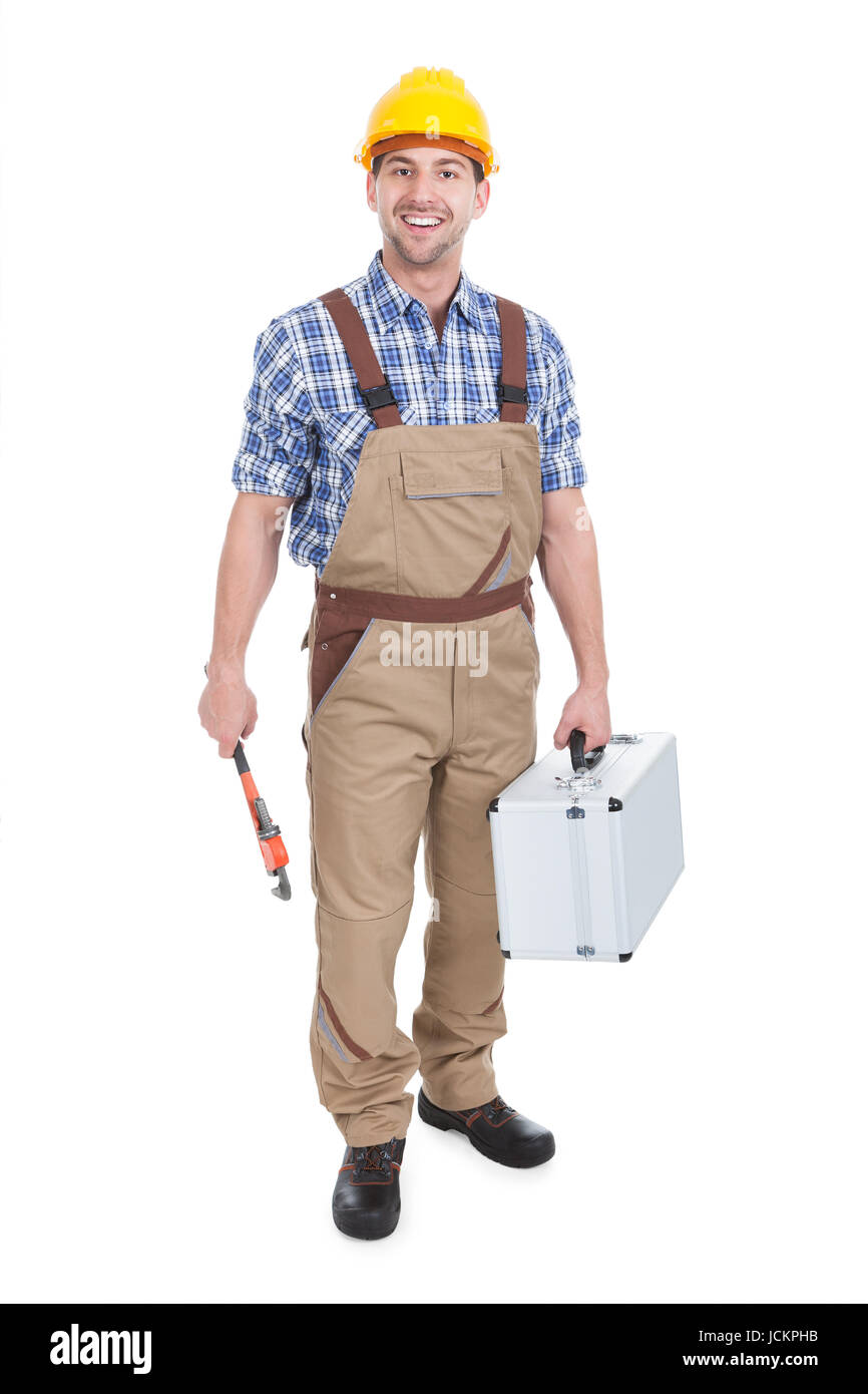 Full length portrait of confident young male worker with wrench and ...