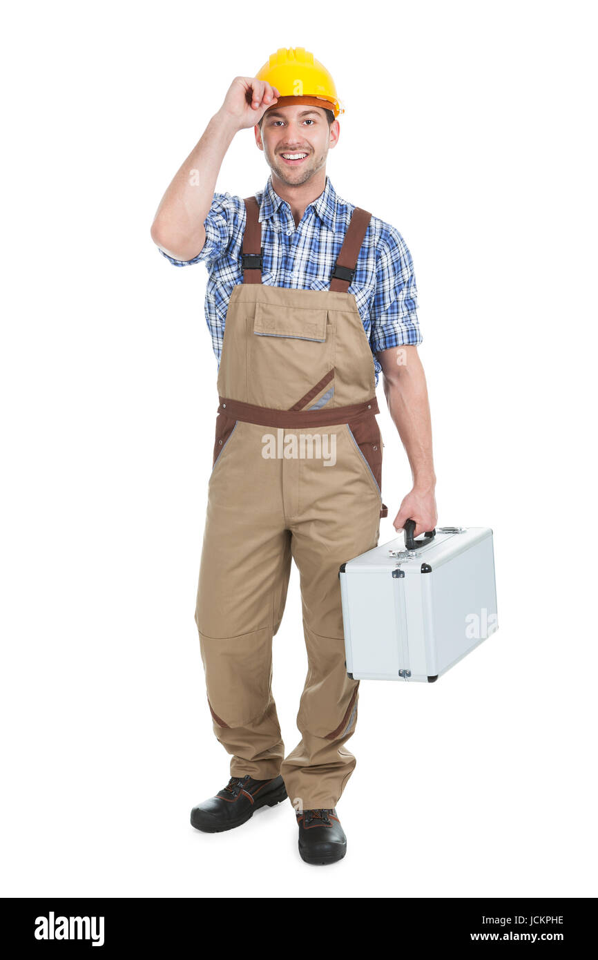 Full length portrait of young manual worker with toolbox over white ...