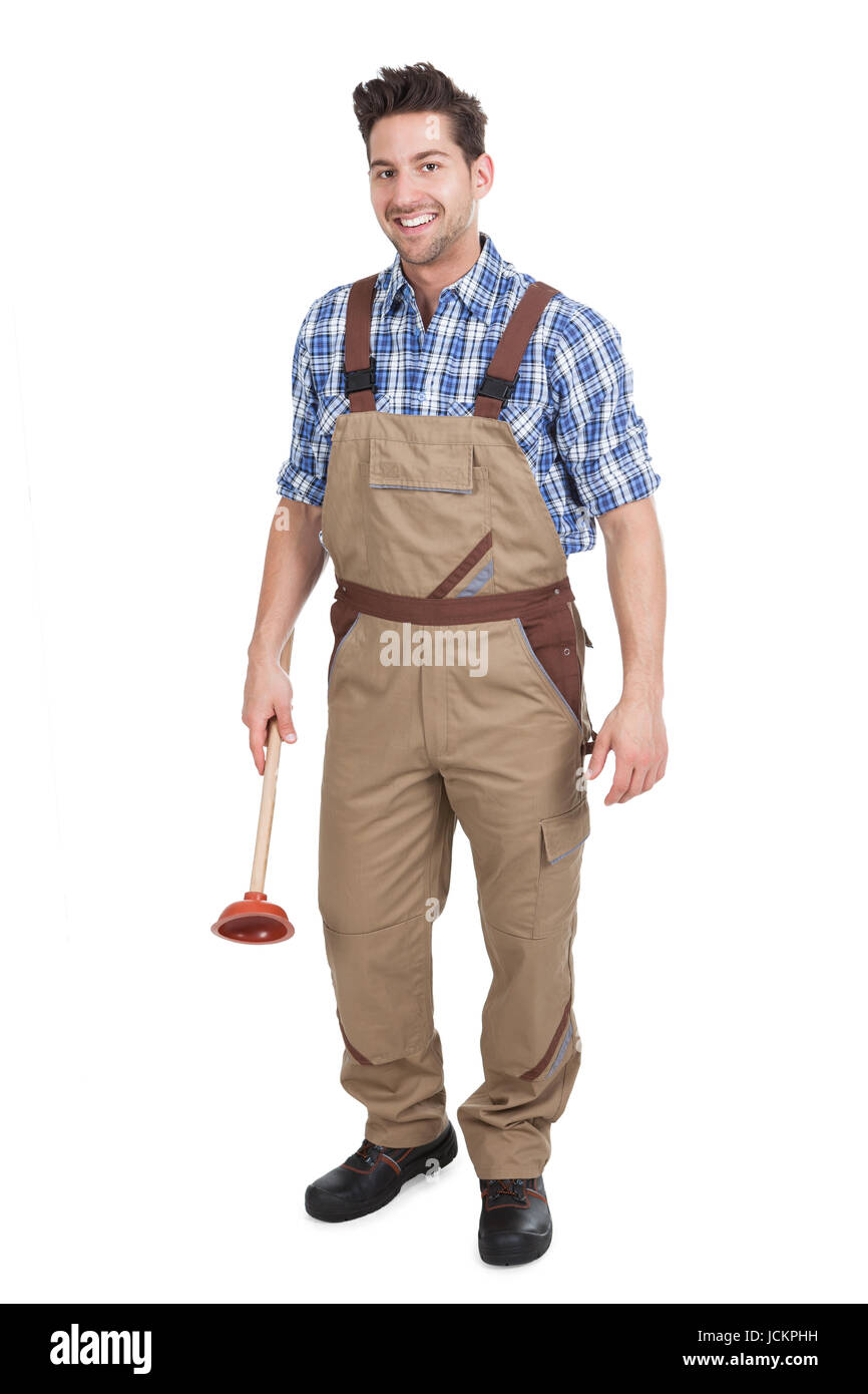 Full length portrait of excited young male plumber holding plunger over ...