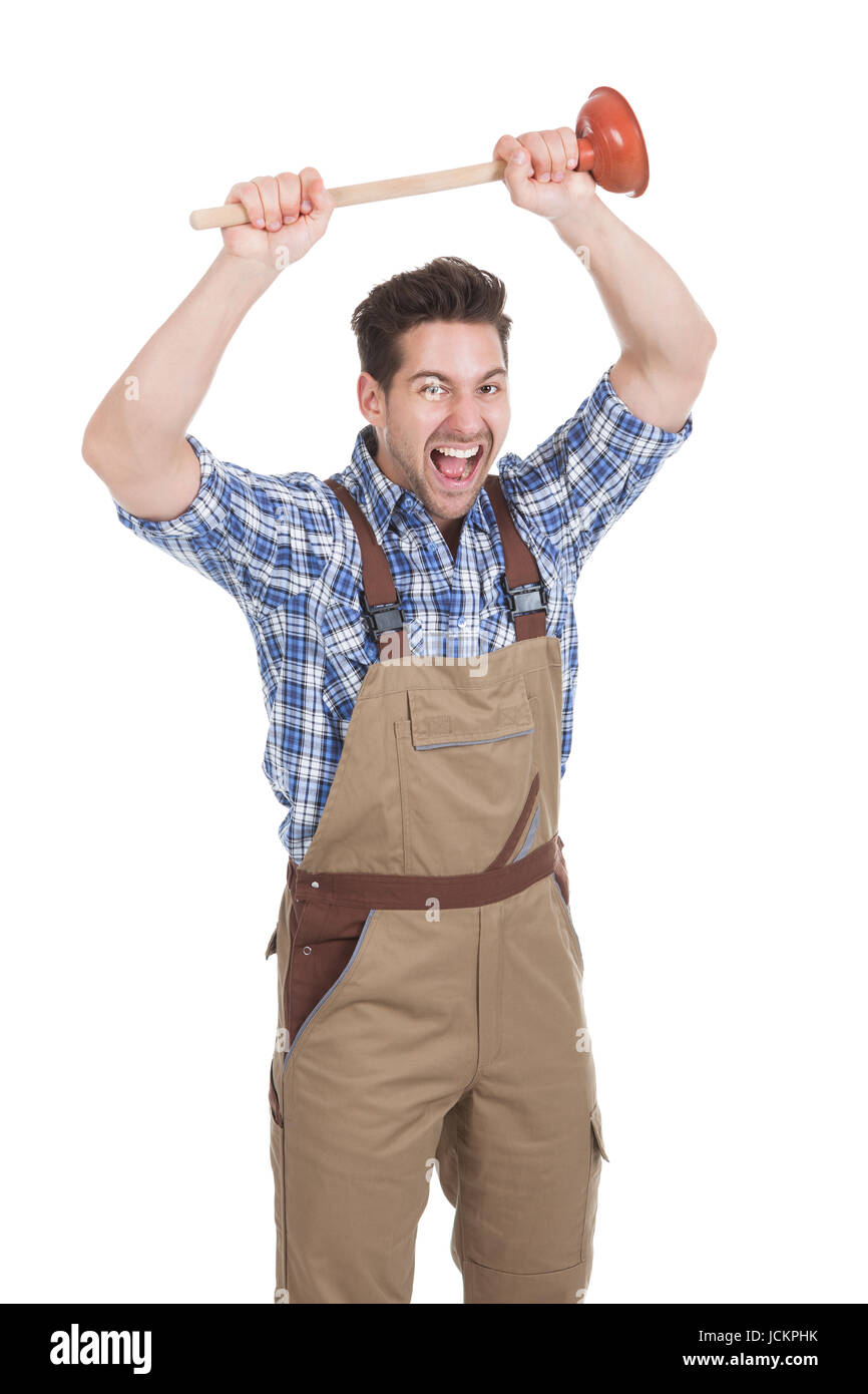 Full length portrait of excited young male plumber holding plunger over ...