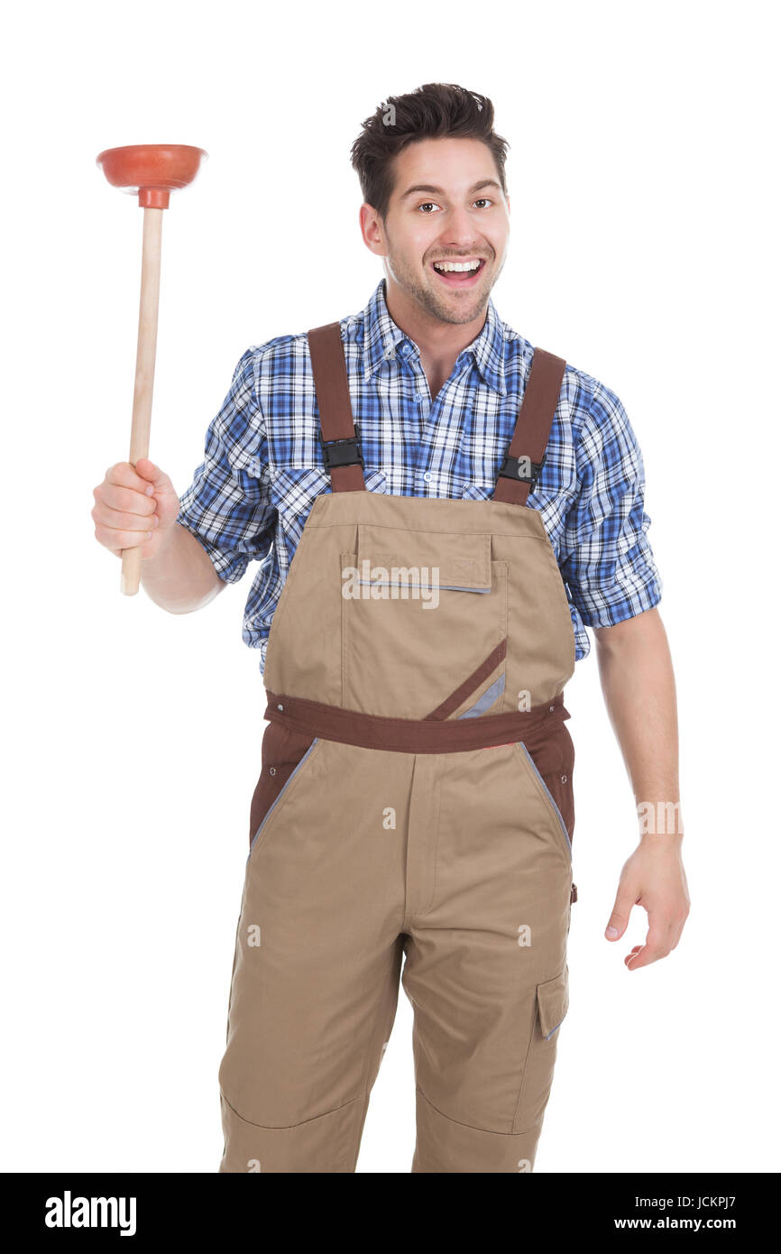 Full length portrait of excited young male plumber holding plunger over ...