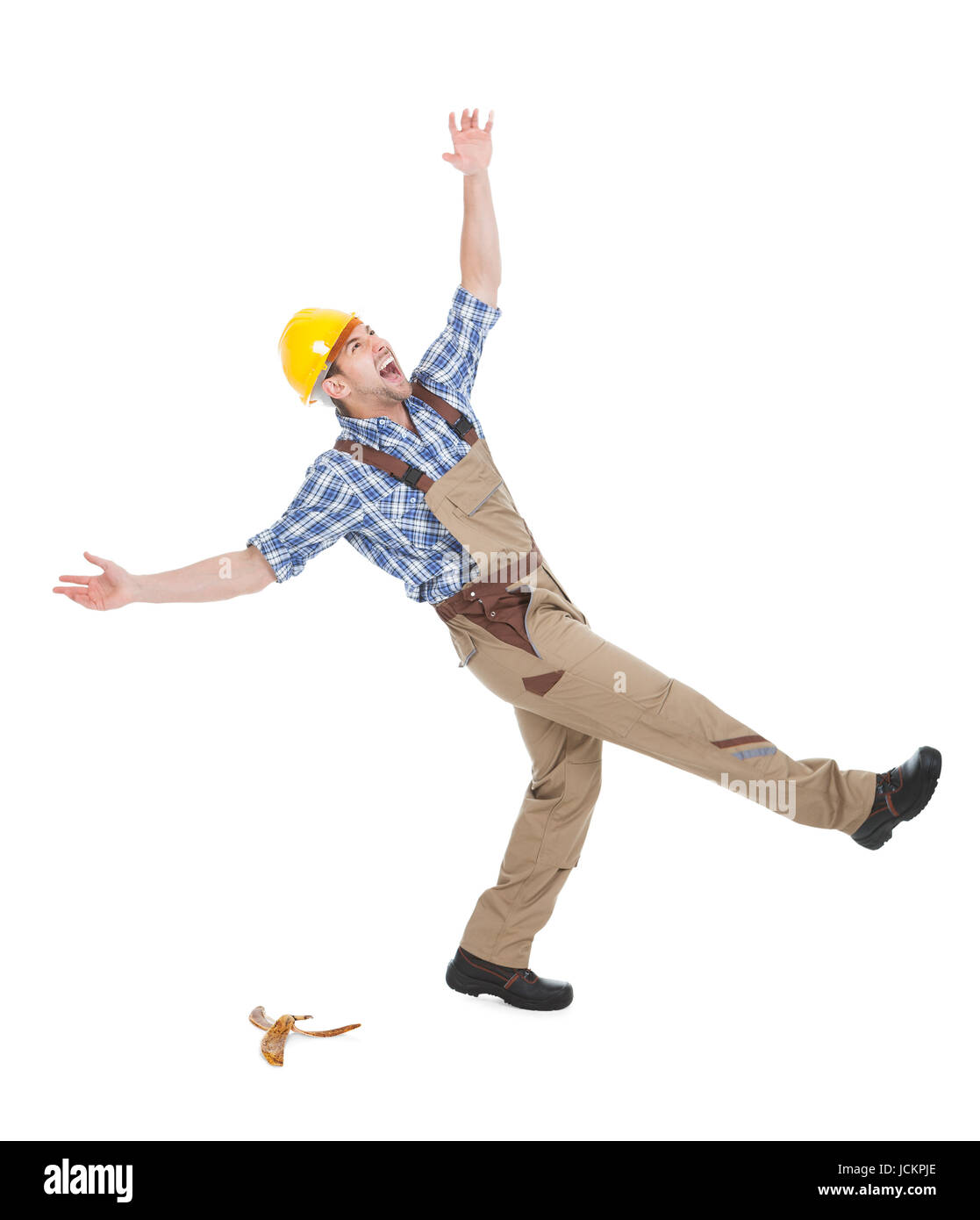 Full length of young manual worker falling over white background Stock ...