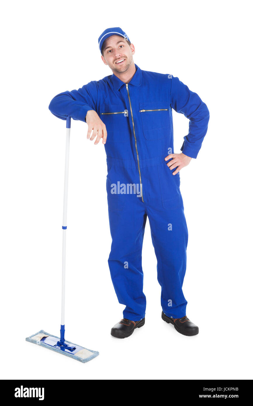 Portrait of confident young cleaner mopping over white background Stock ...