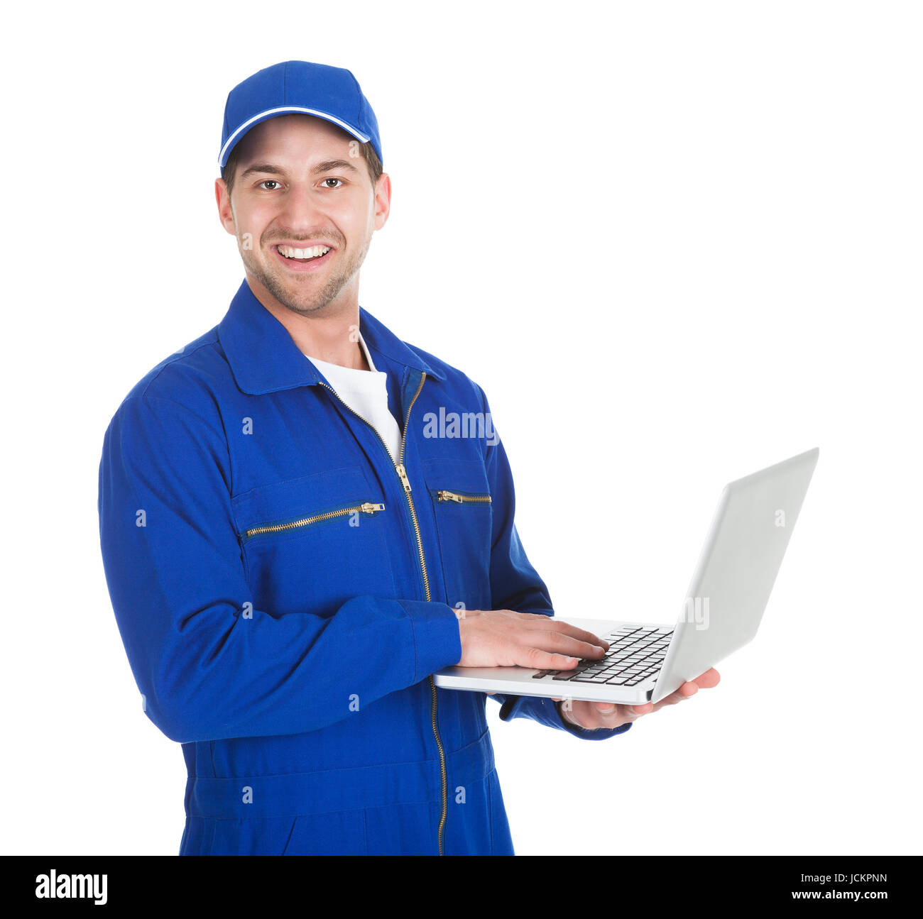 Young mechanic using laptop over white background Stock Photo - Alamy