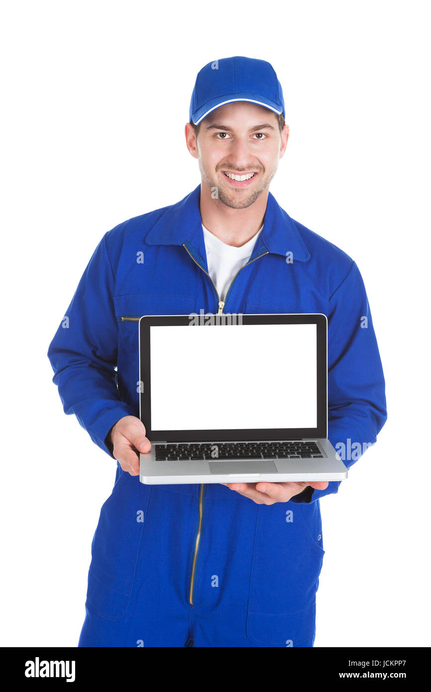 Young male mechanic displaying laptop over white background Stock Photo ...