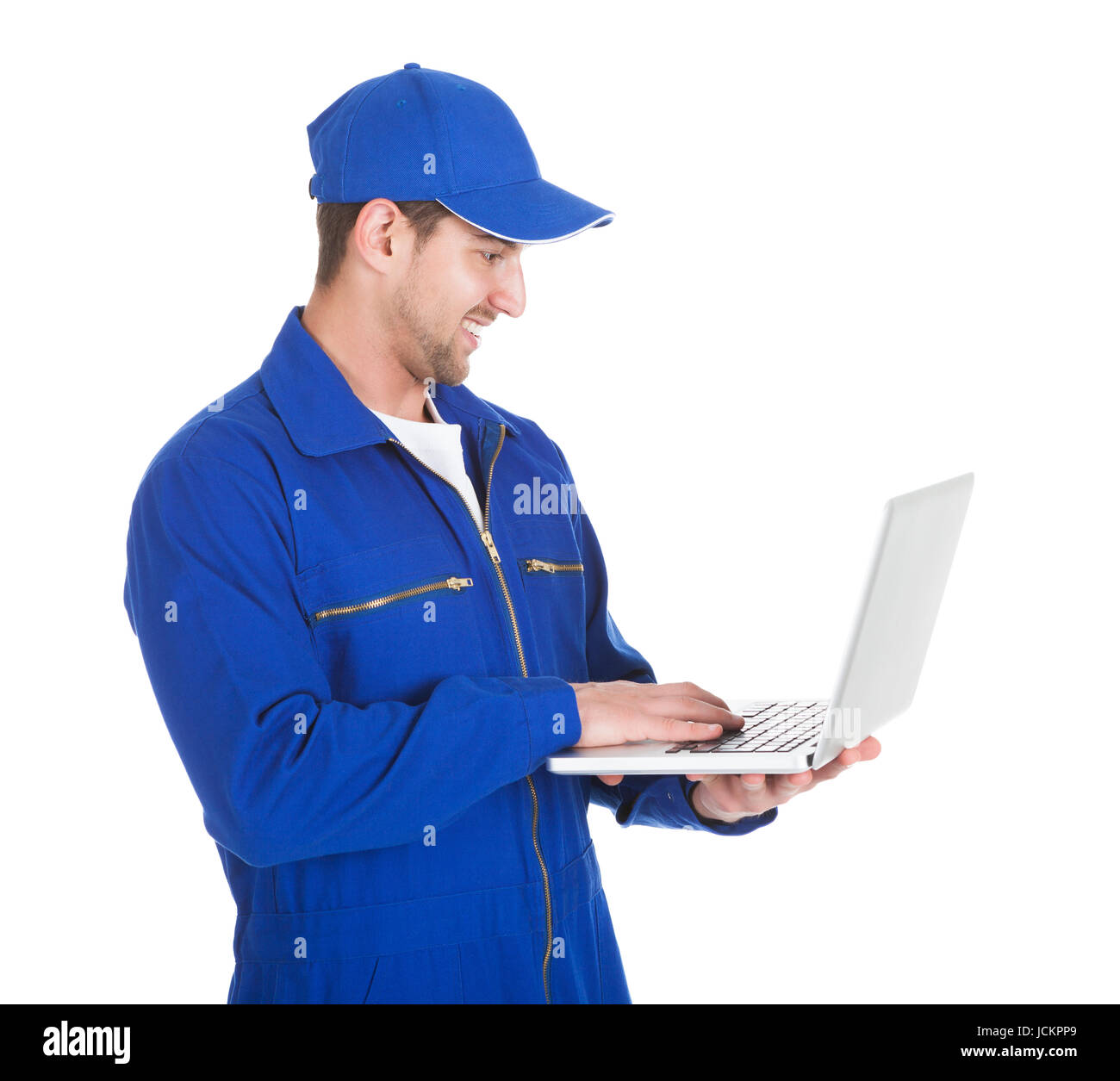 Young mechanic using laptop over white background Stock Photo - Alamy