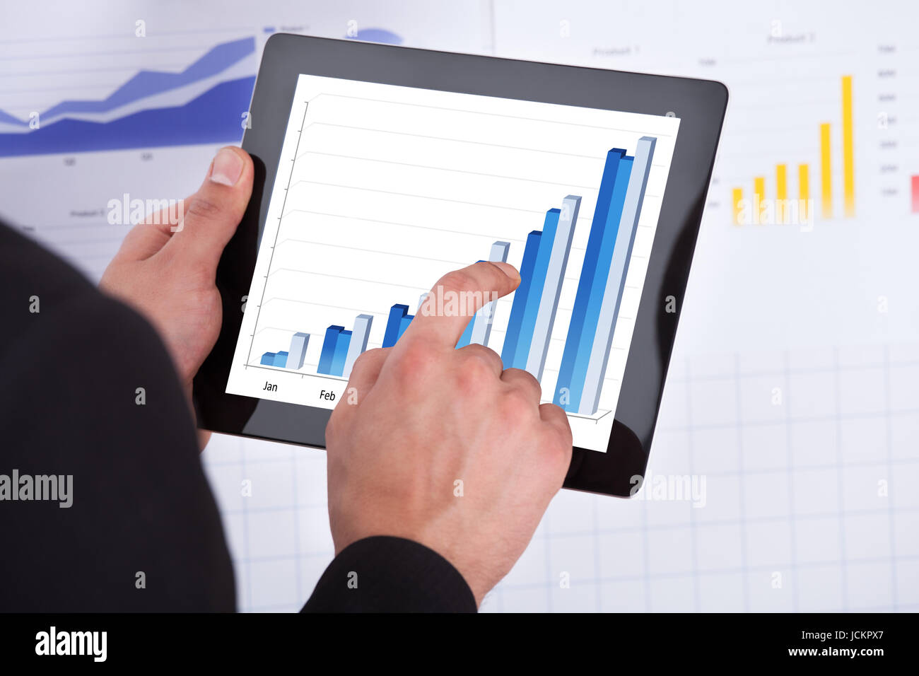 Cropped image of businessman analyzing bar graph on digital tablet in ...