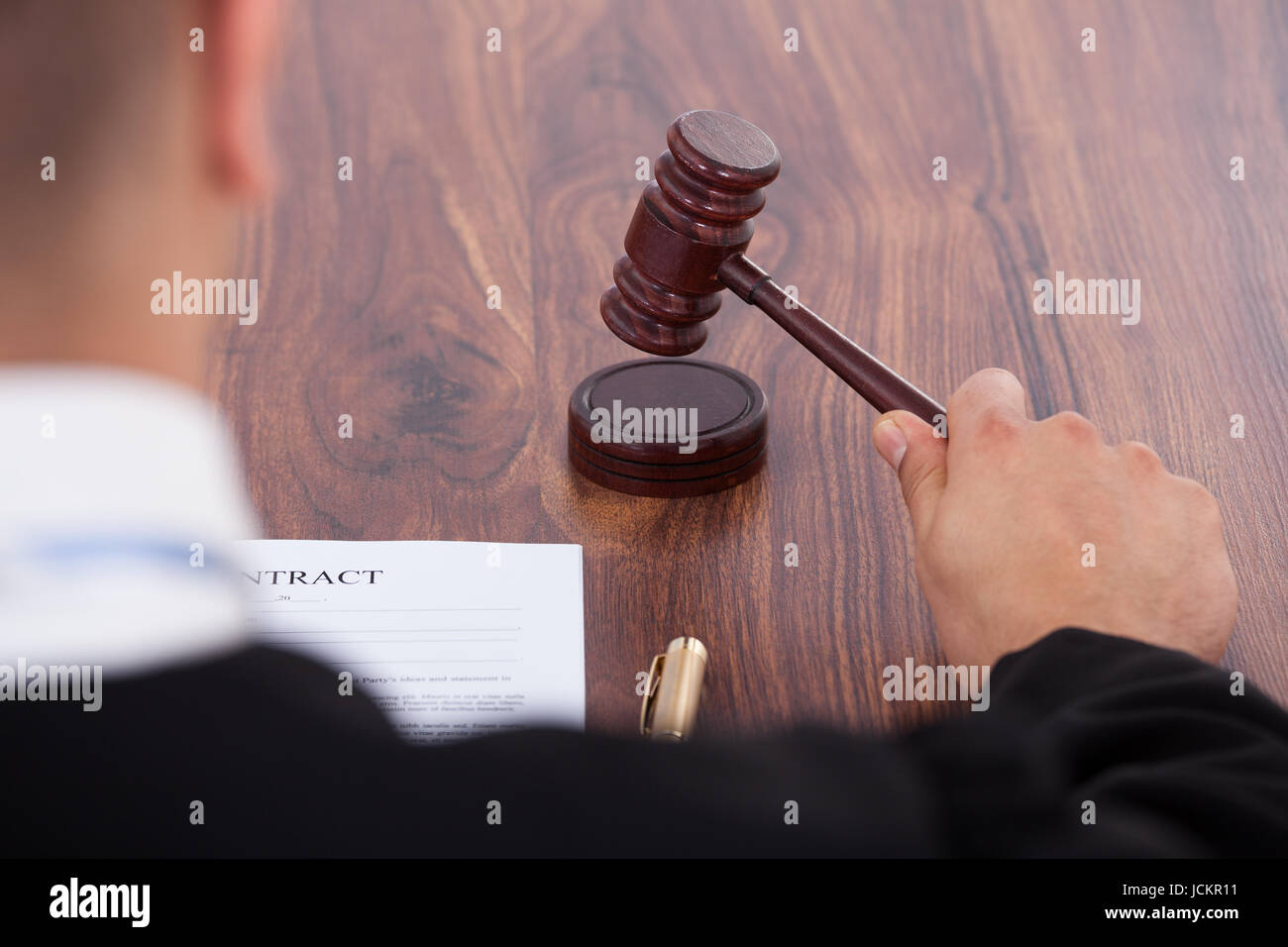 Cropped image of judge knocking gavel in courtroom Stock Photo - Alamy