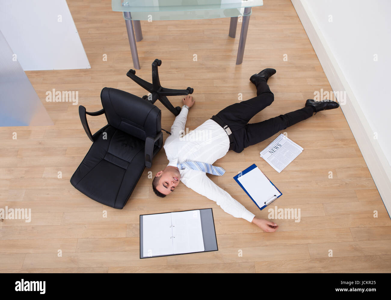 Full length of young businessman fallen from office chair Stock Photo ...