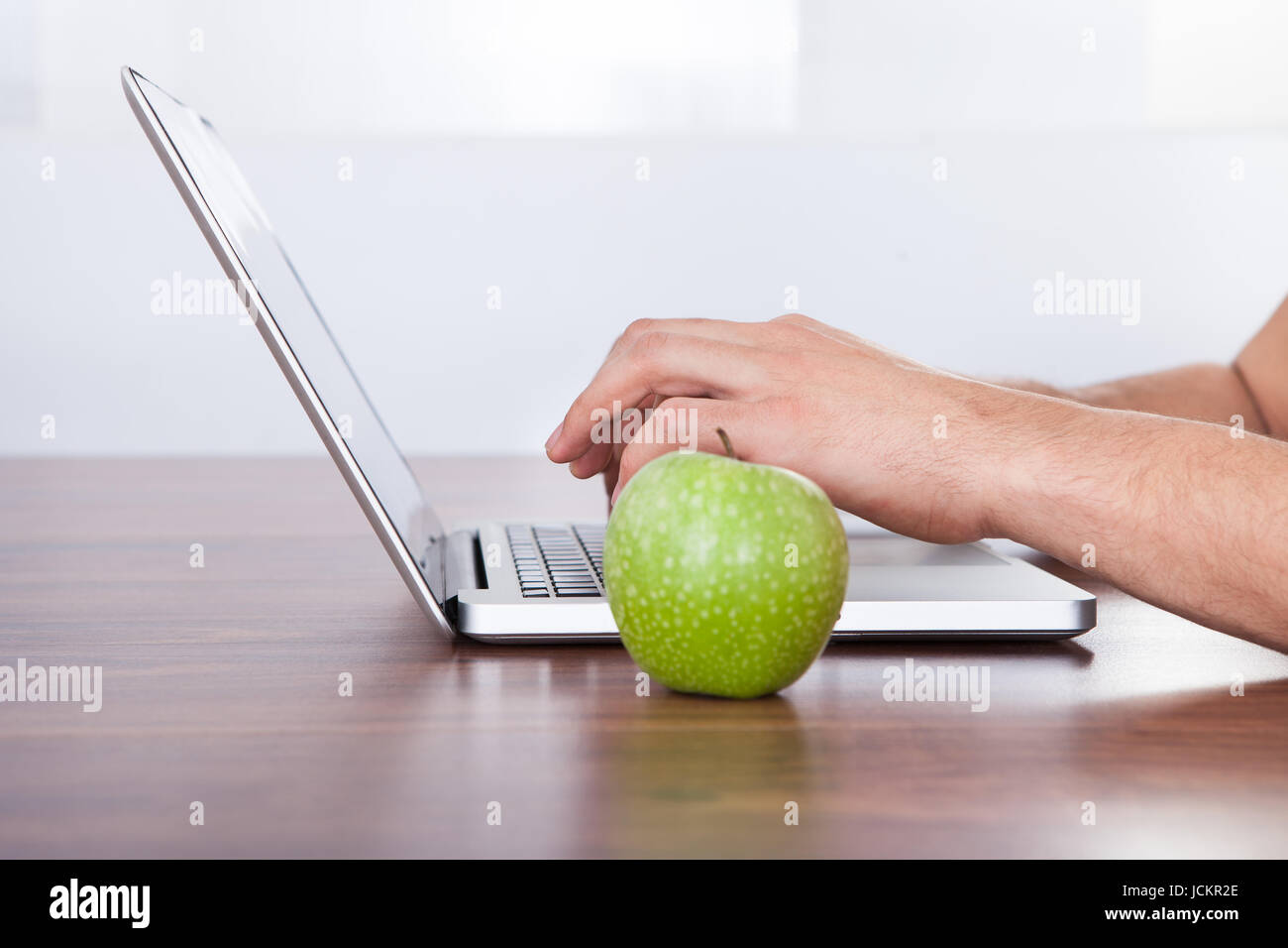 Cropped image of young male student solving math's problem on laptop by ...