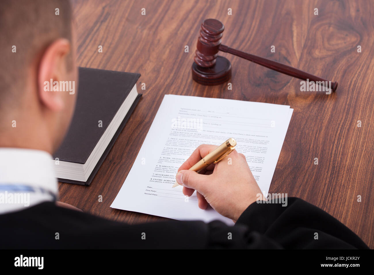 Cropped image of judge signing document in courtroom Stock Photo - Alamy
