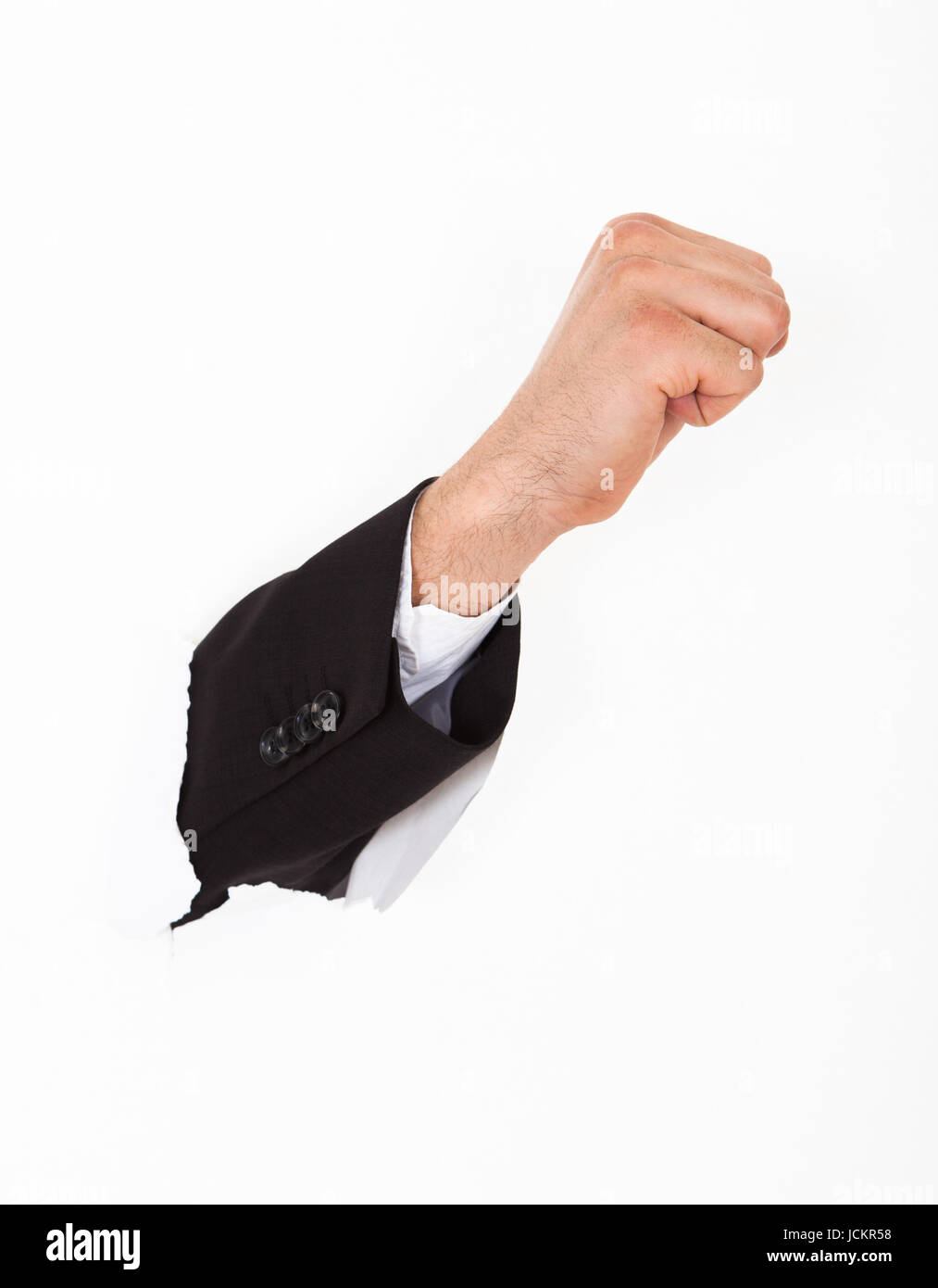 Businessman's fist breaking through white paper wall Stock Photo - Alamy