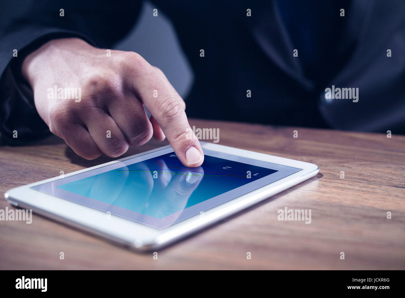 Mans hand touching on a tablet computer Stock Photo - Alamy