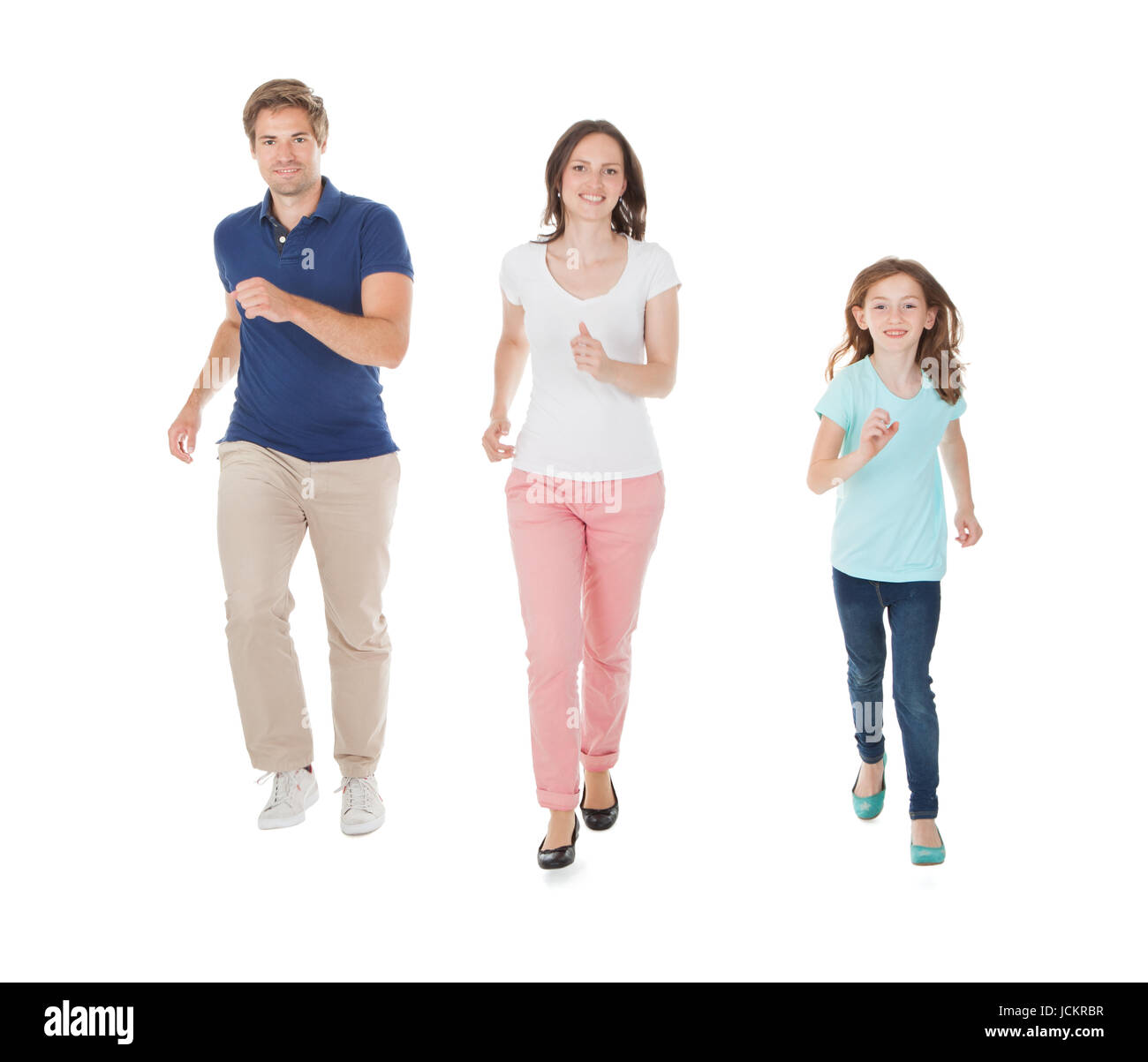 Full length portrait of happy family running against white background ...