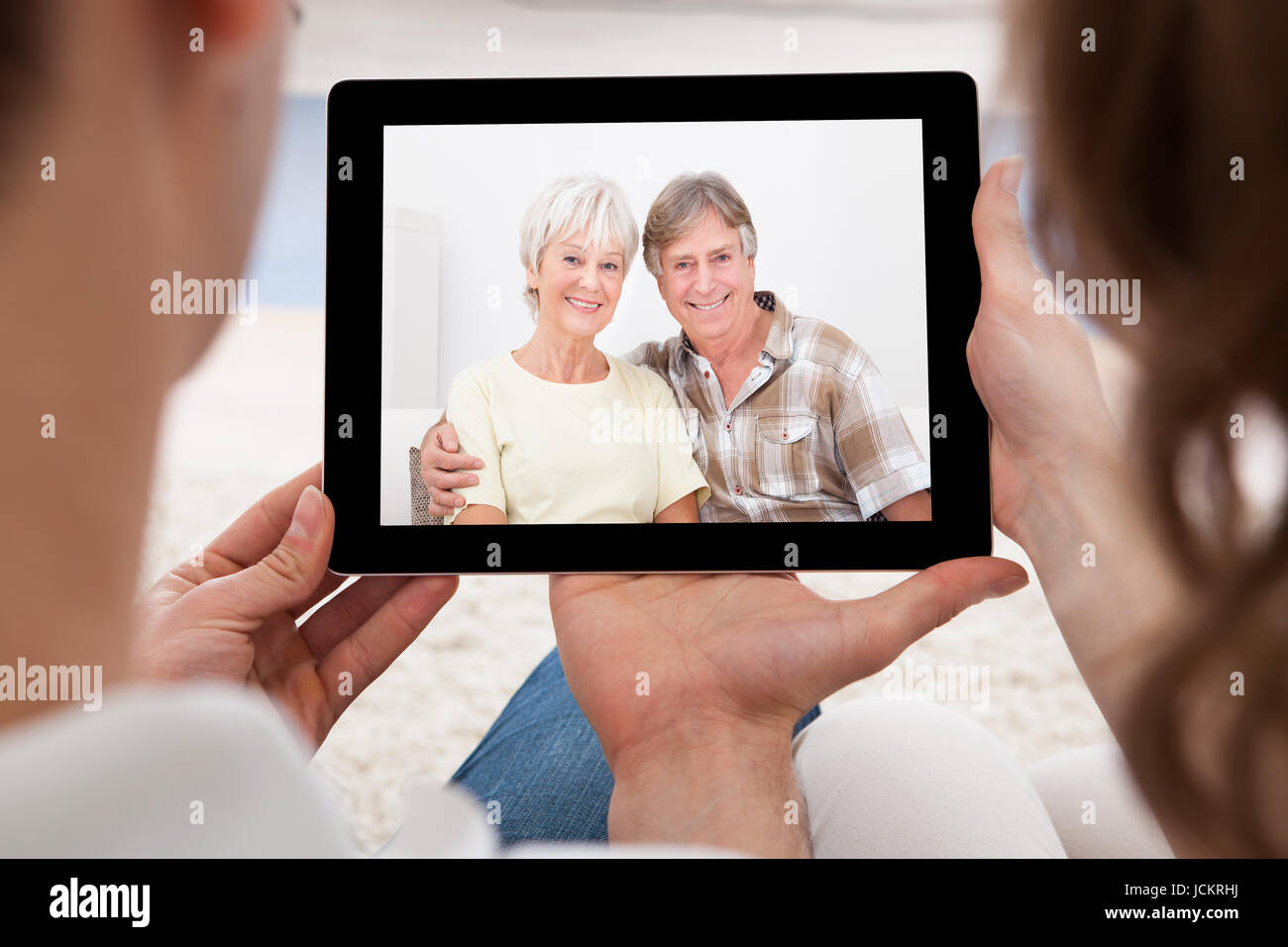Loving couple having online video conference at home Stock Photo - Alamy